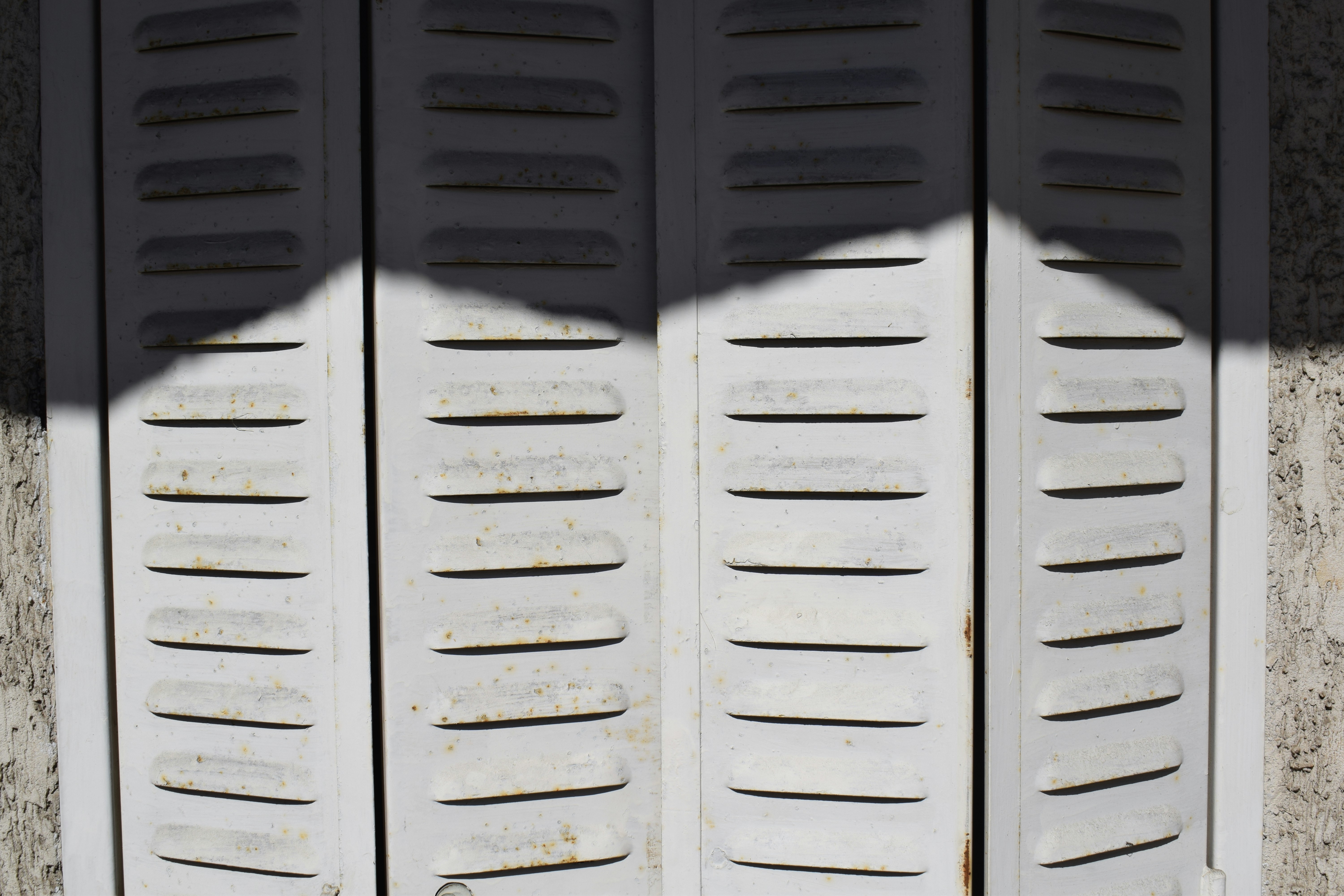 Shadowed Vertical Slats: A Quiet Wall Between Light Bands