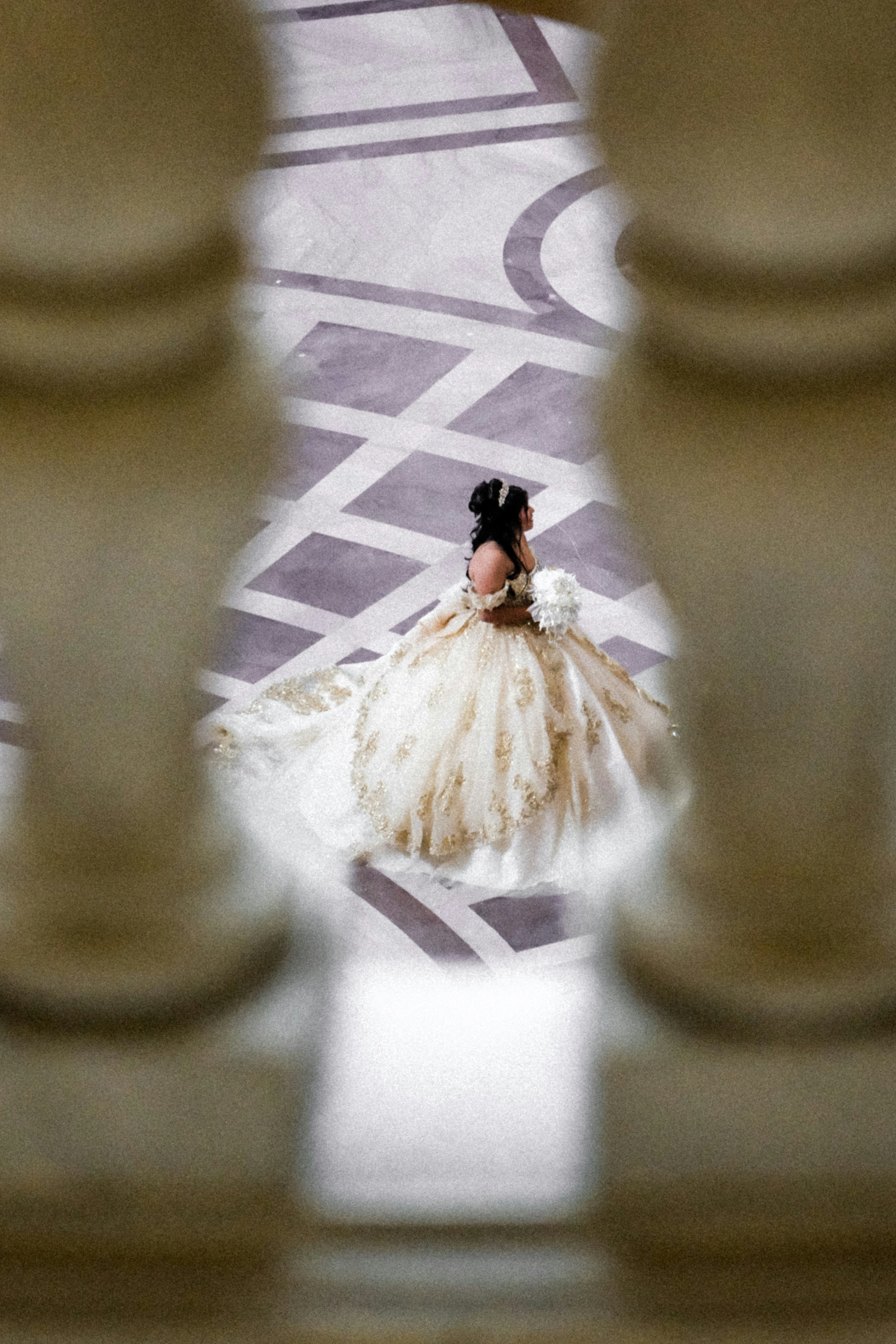 Princess in a gilded gown framed by architectural columns
