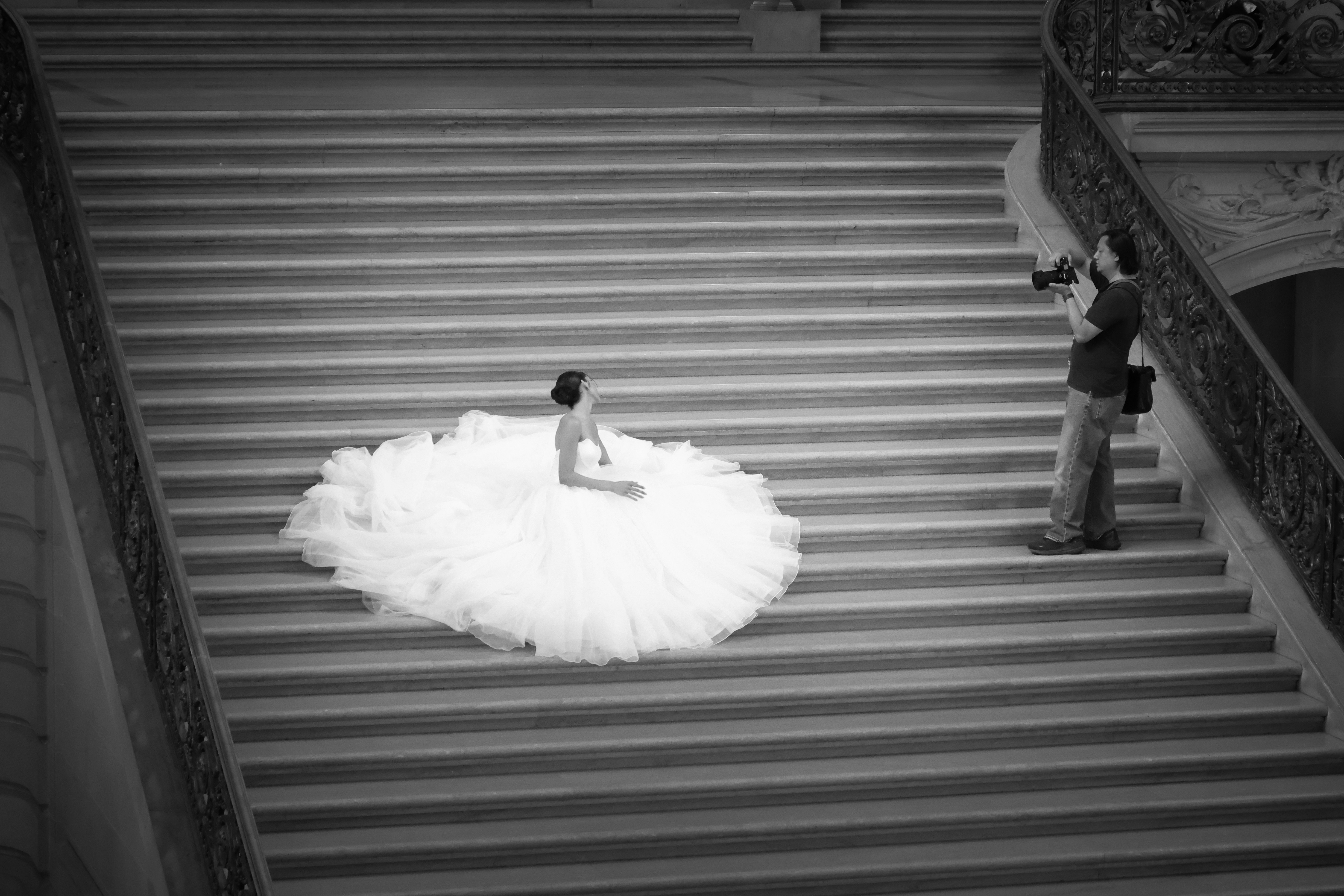 Elegance on the Grand Stair: A Bride in a Whirl of Tiers
