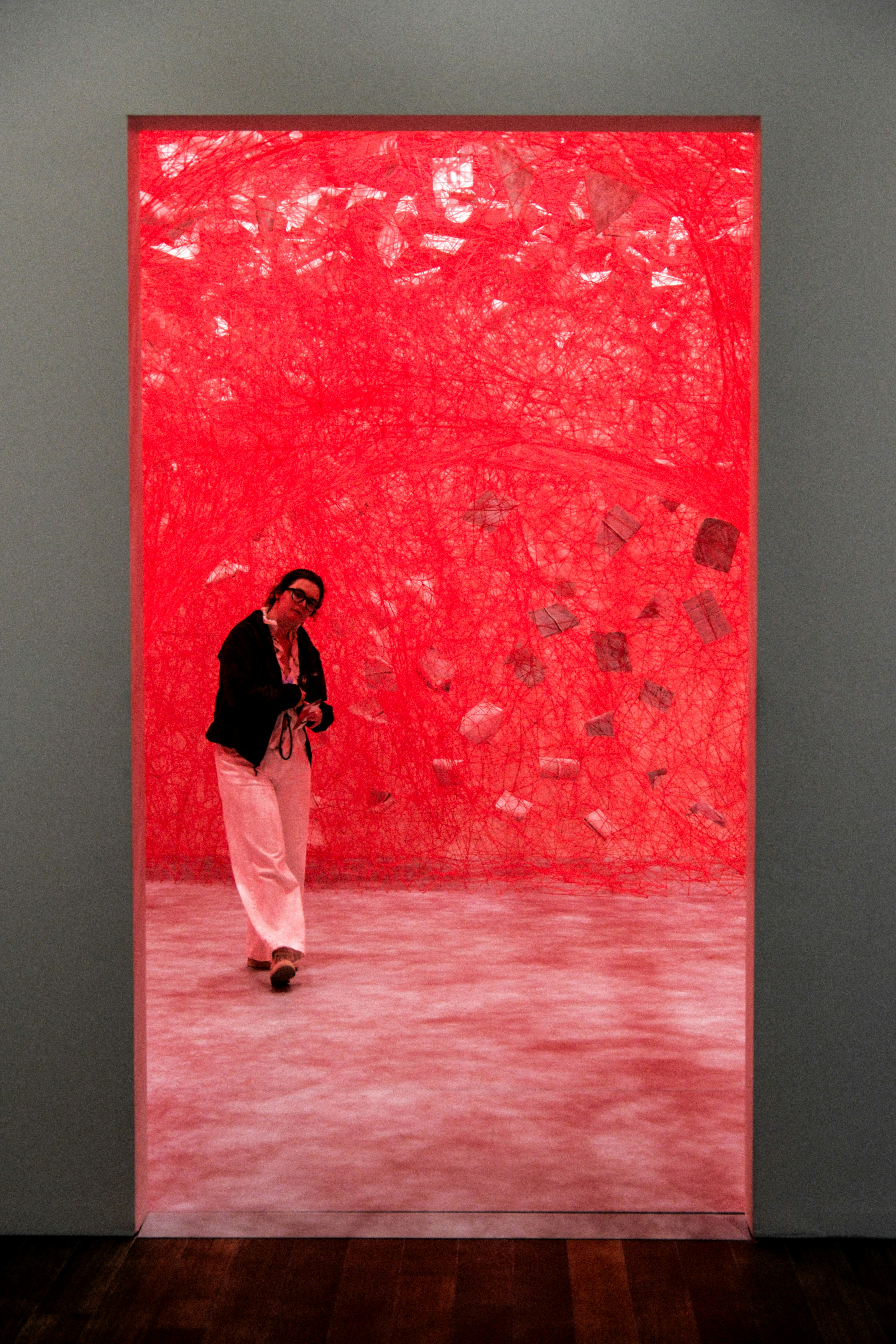 Red Threshold: A Figure Steps Through a Painted Portal