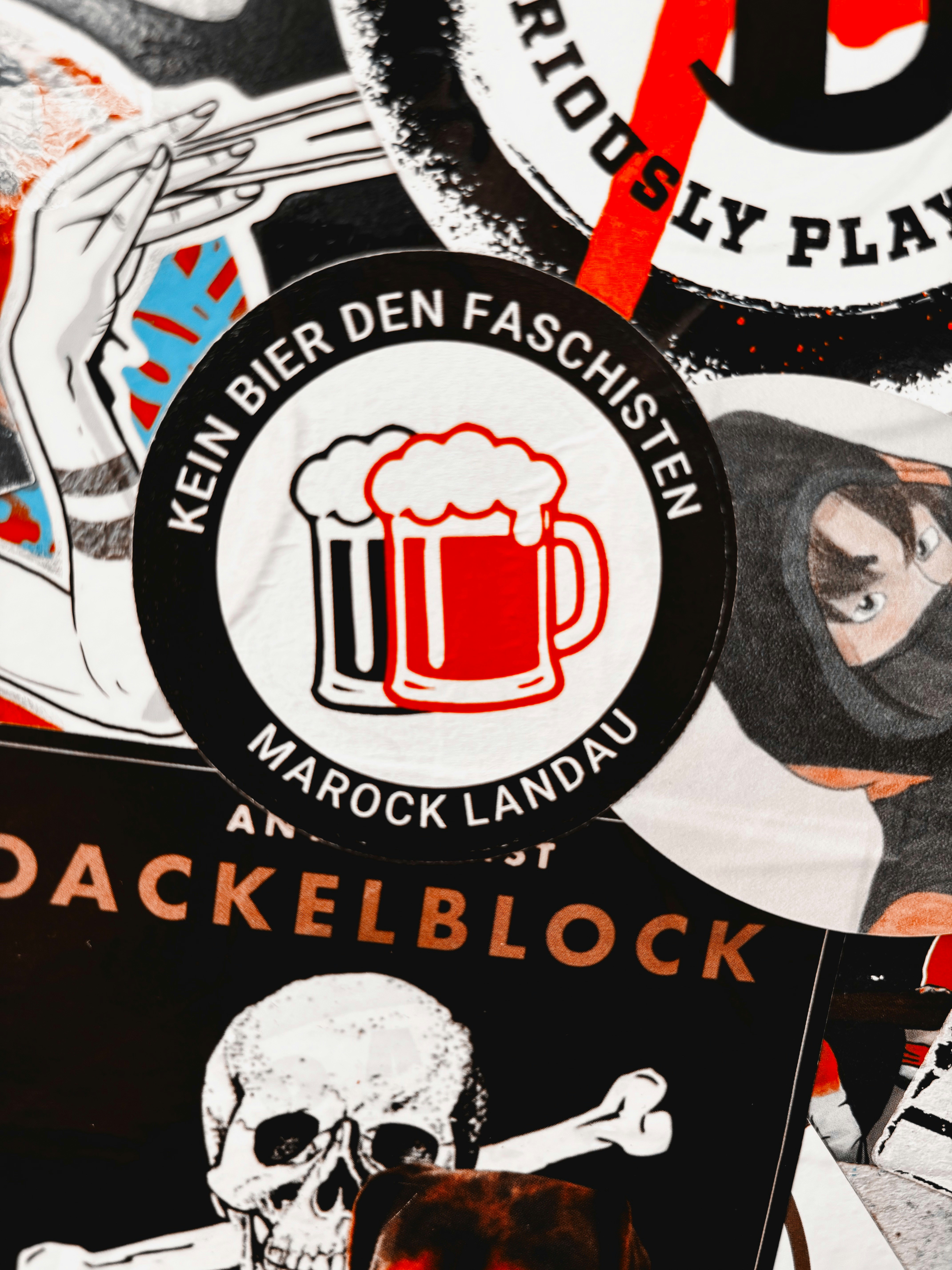 Sticker Collage with Beer Mug Emblem on Dark Deck