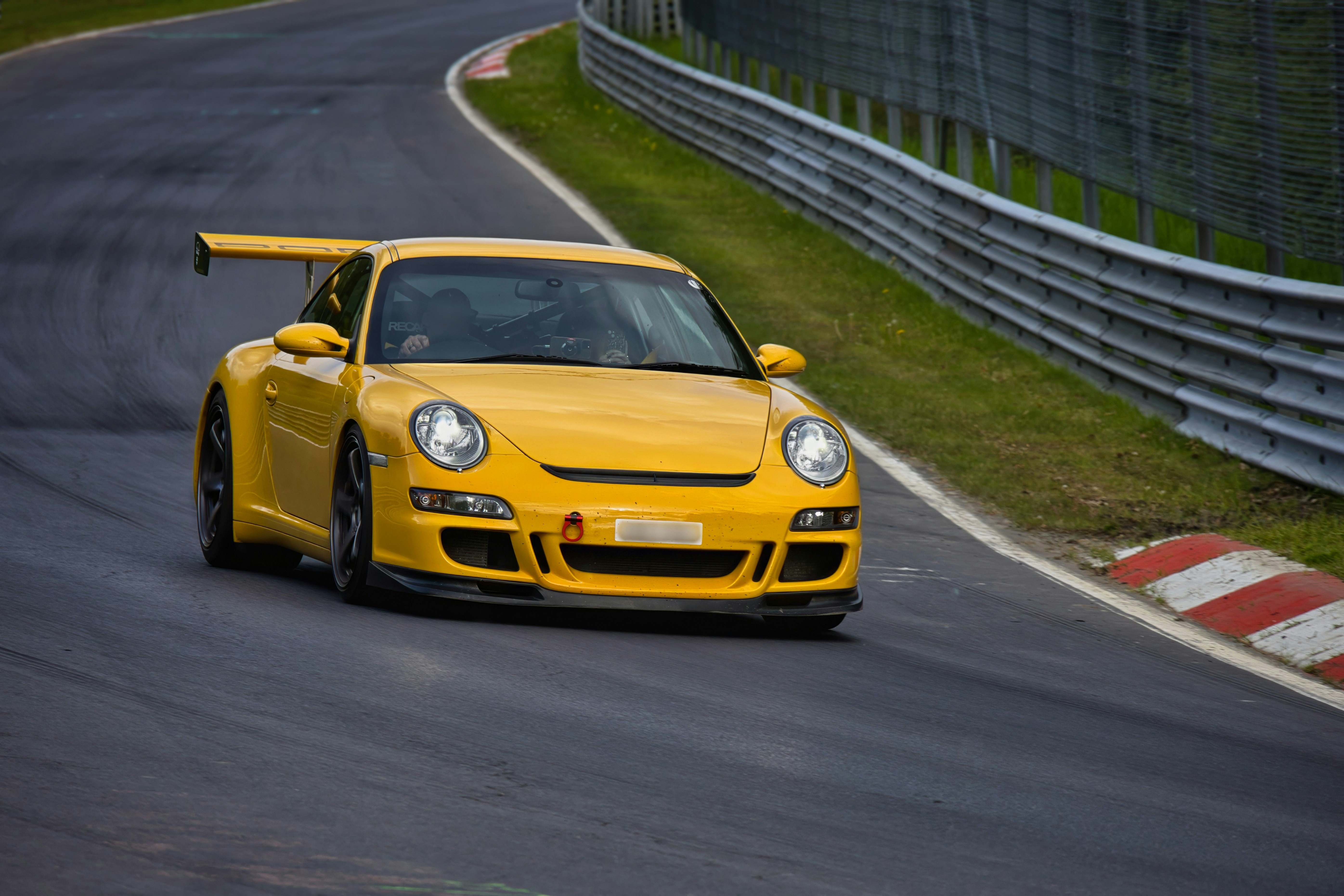 Yellow Porsche Mach 1 Slices the Rain at a Curved Track