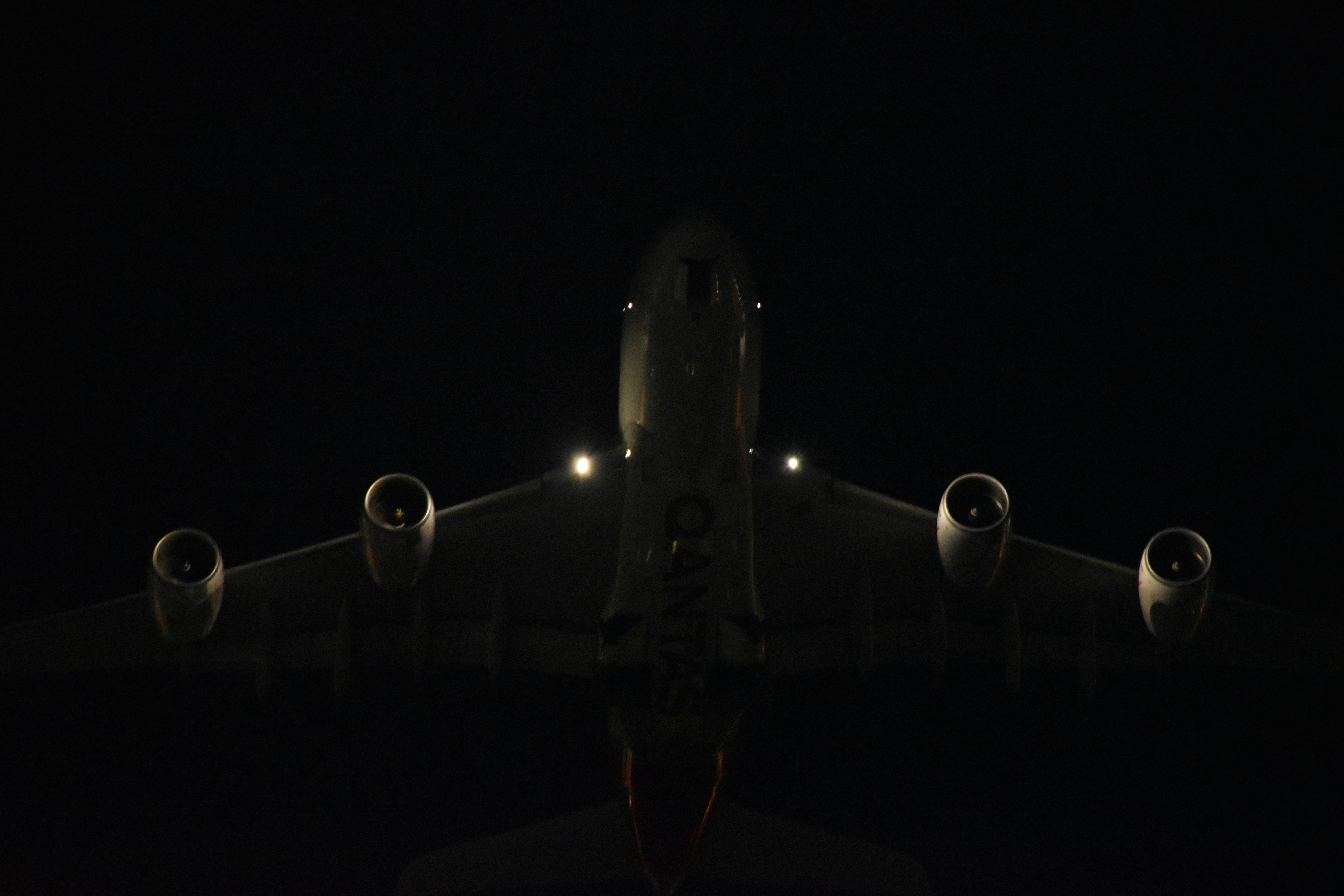 Underbelly Ascent: A Night Front-On of a Four-Engine Giant