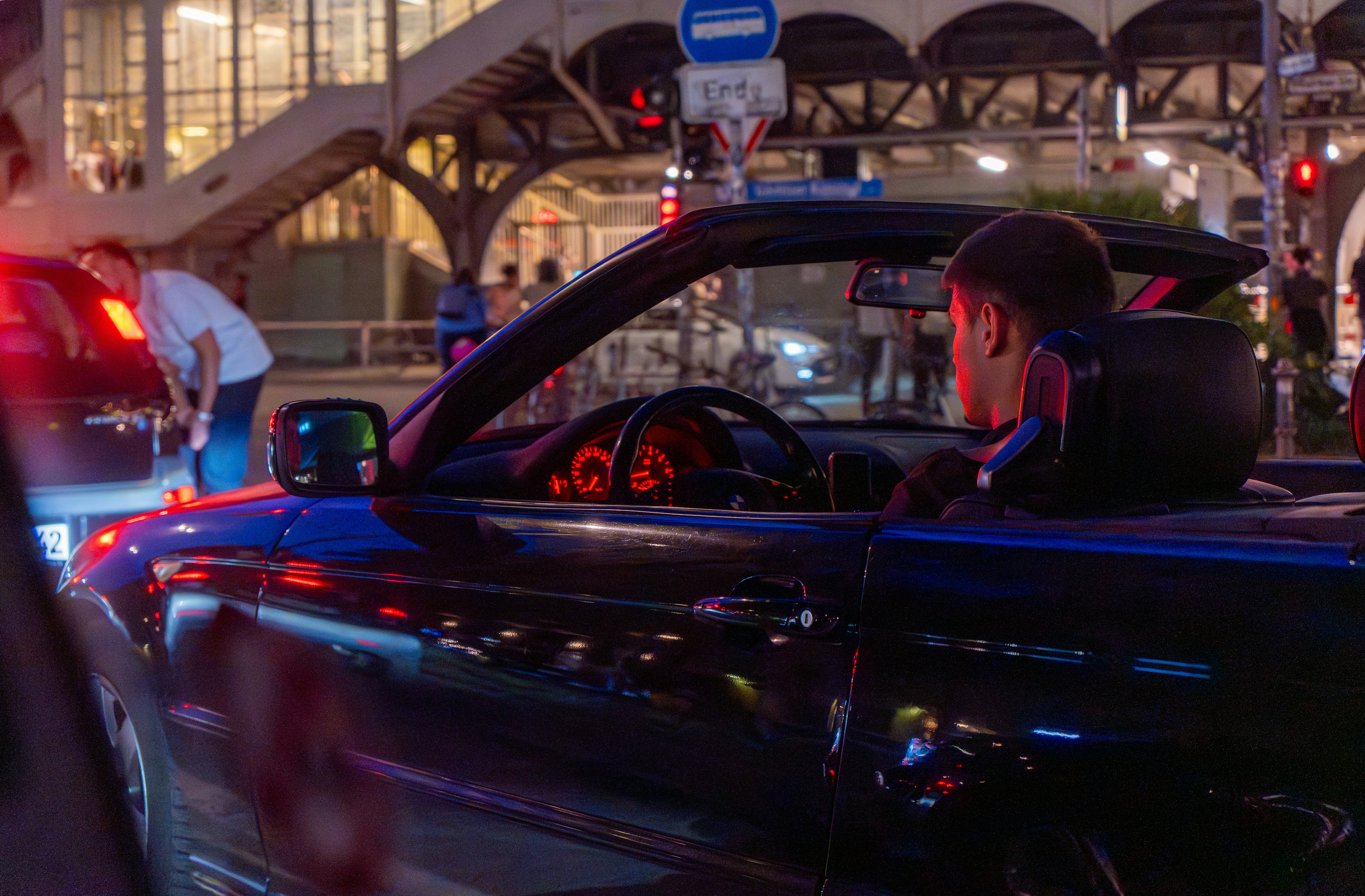 Midnight Convertible at a Bustling City Intersection