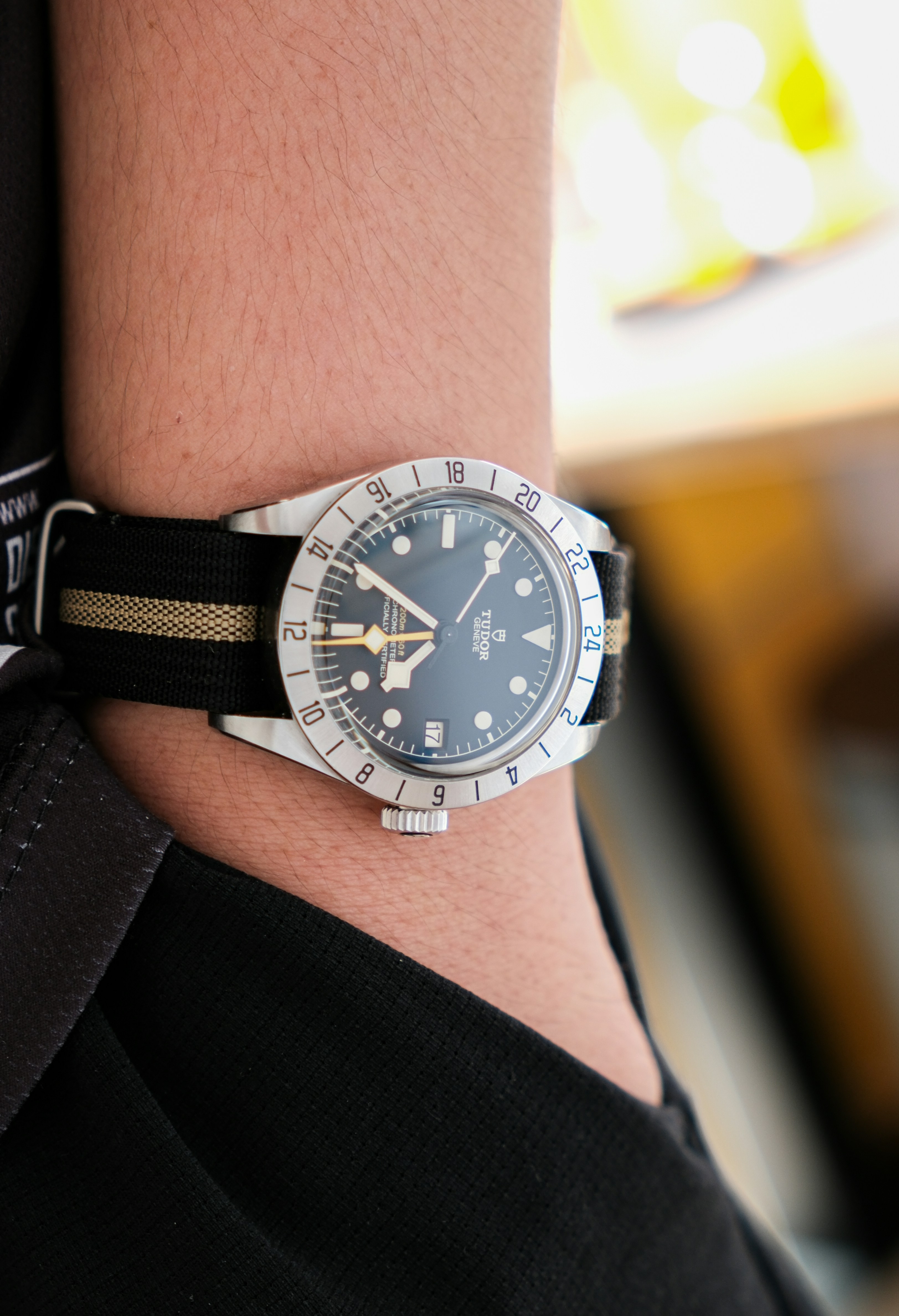 Stainless Steel Dive Watch Resting on a Wrist with Black Nylon Strap