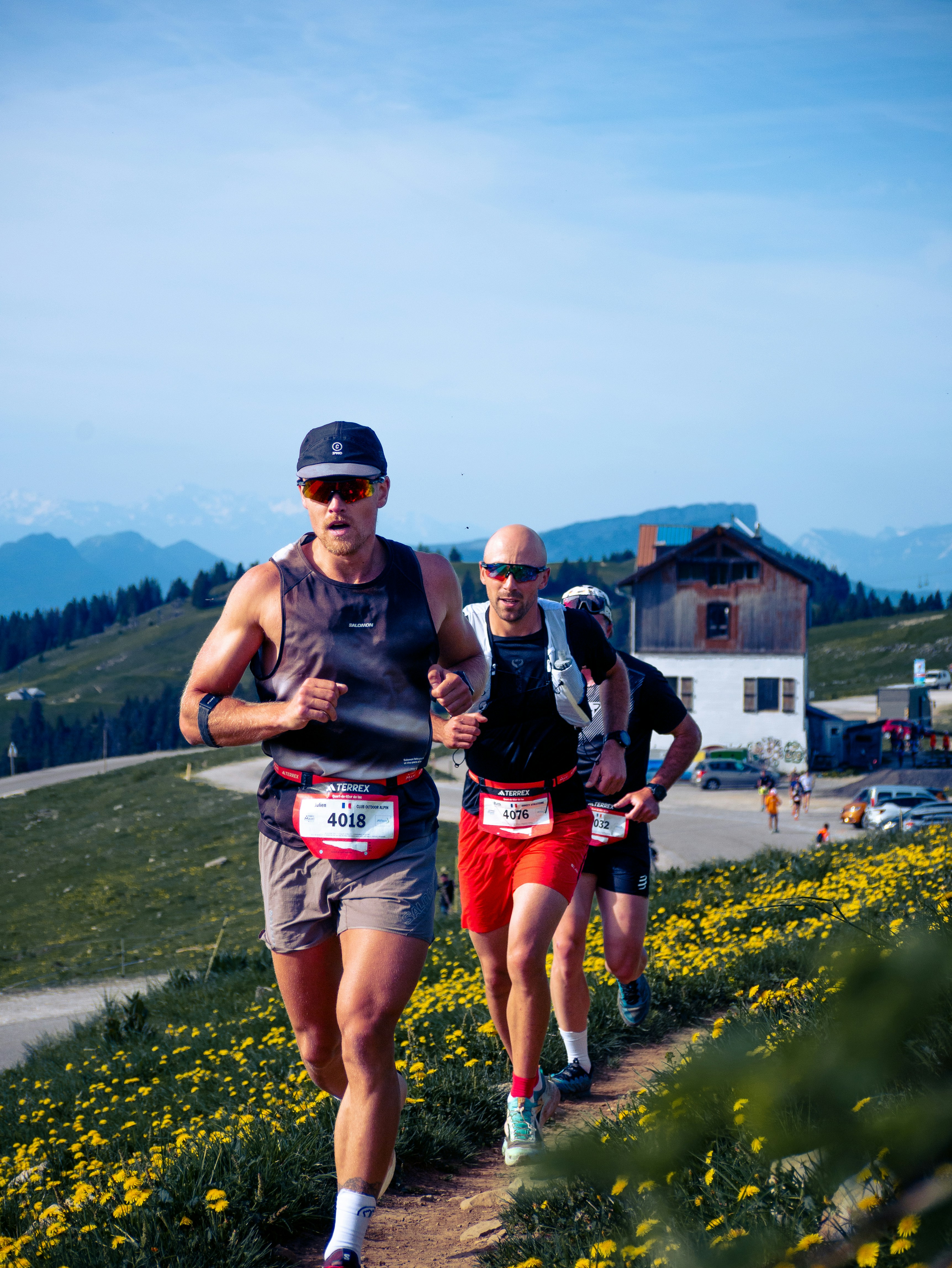 Runners Uphill: A Mountain Stride Through Yellow Blooms