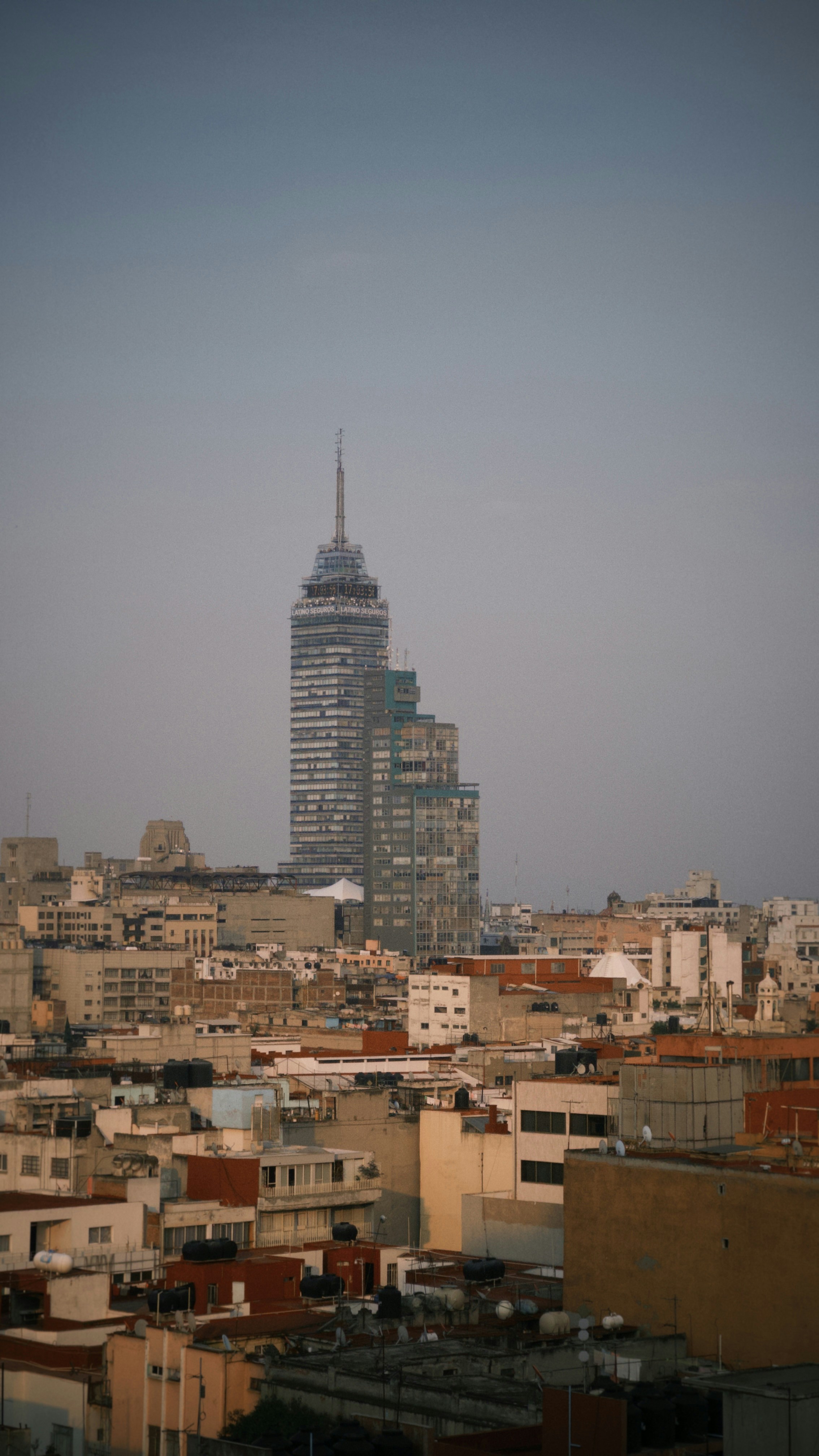 City Needle Rising: A Towering Skyline Above Quiet Rooftops