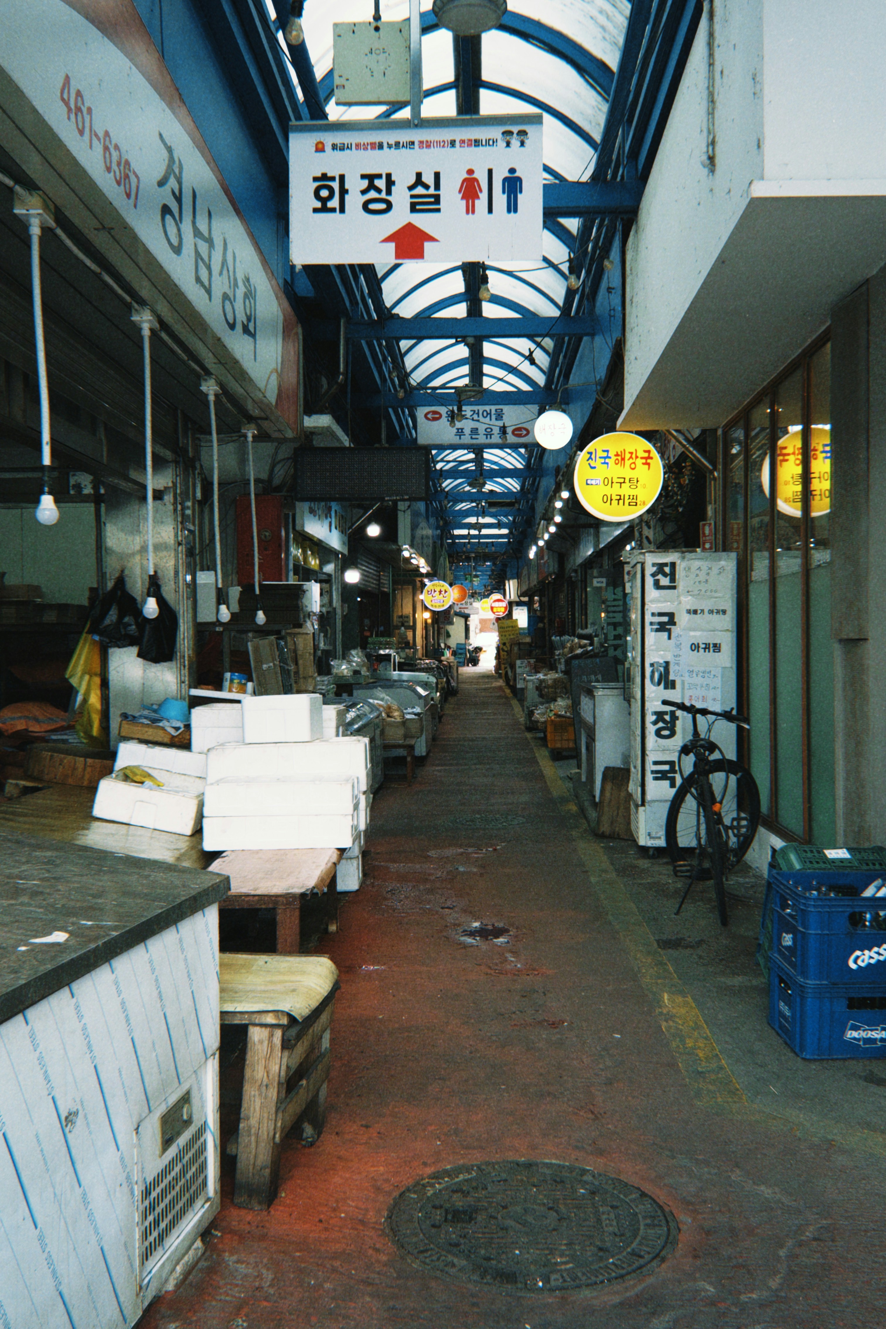 Narrow Market Corridor with Overhead Signage