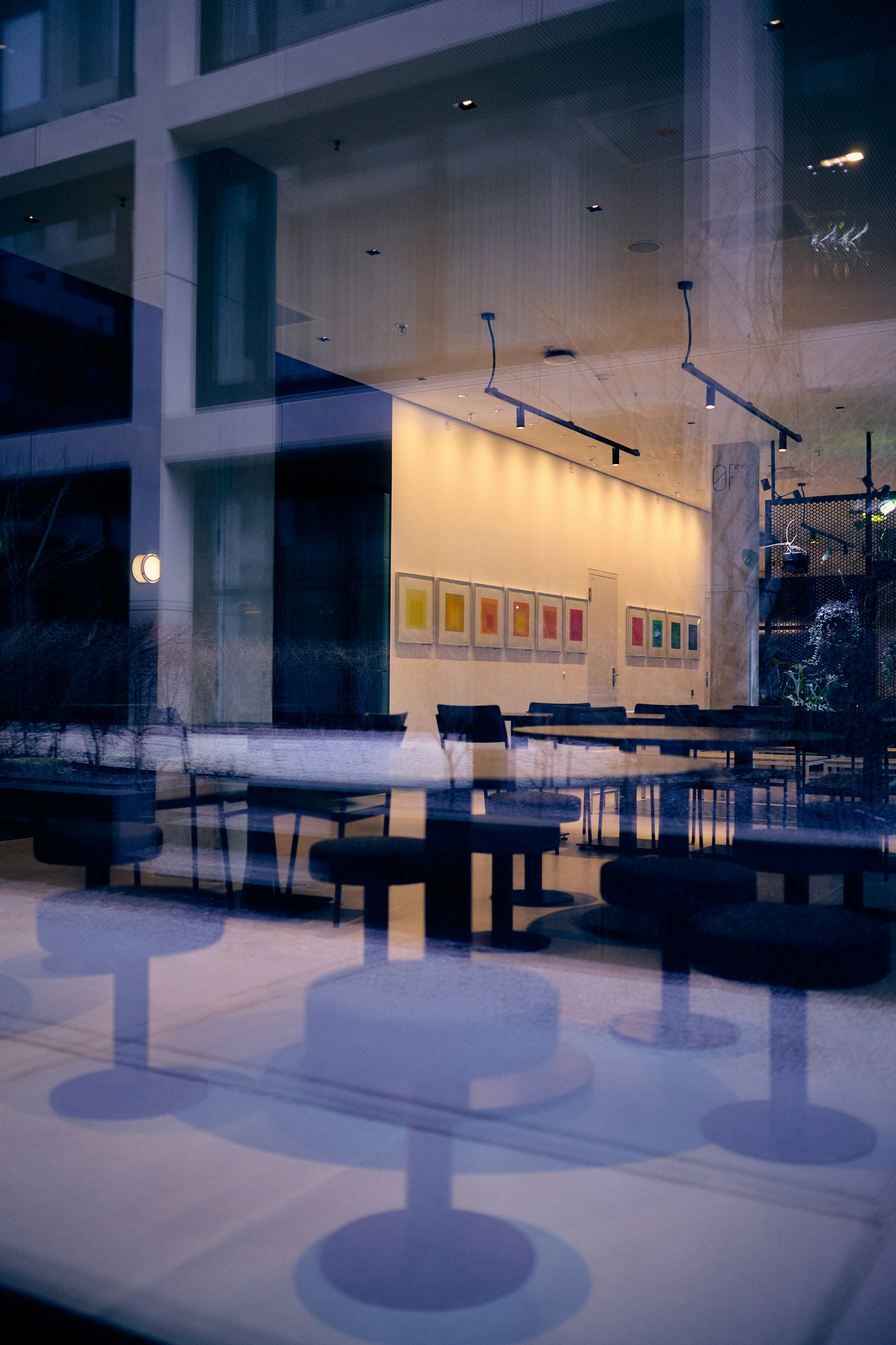 Quiet Gallery Reflections: Colorful Frames through a Glassy Evening