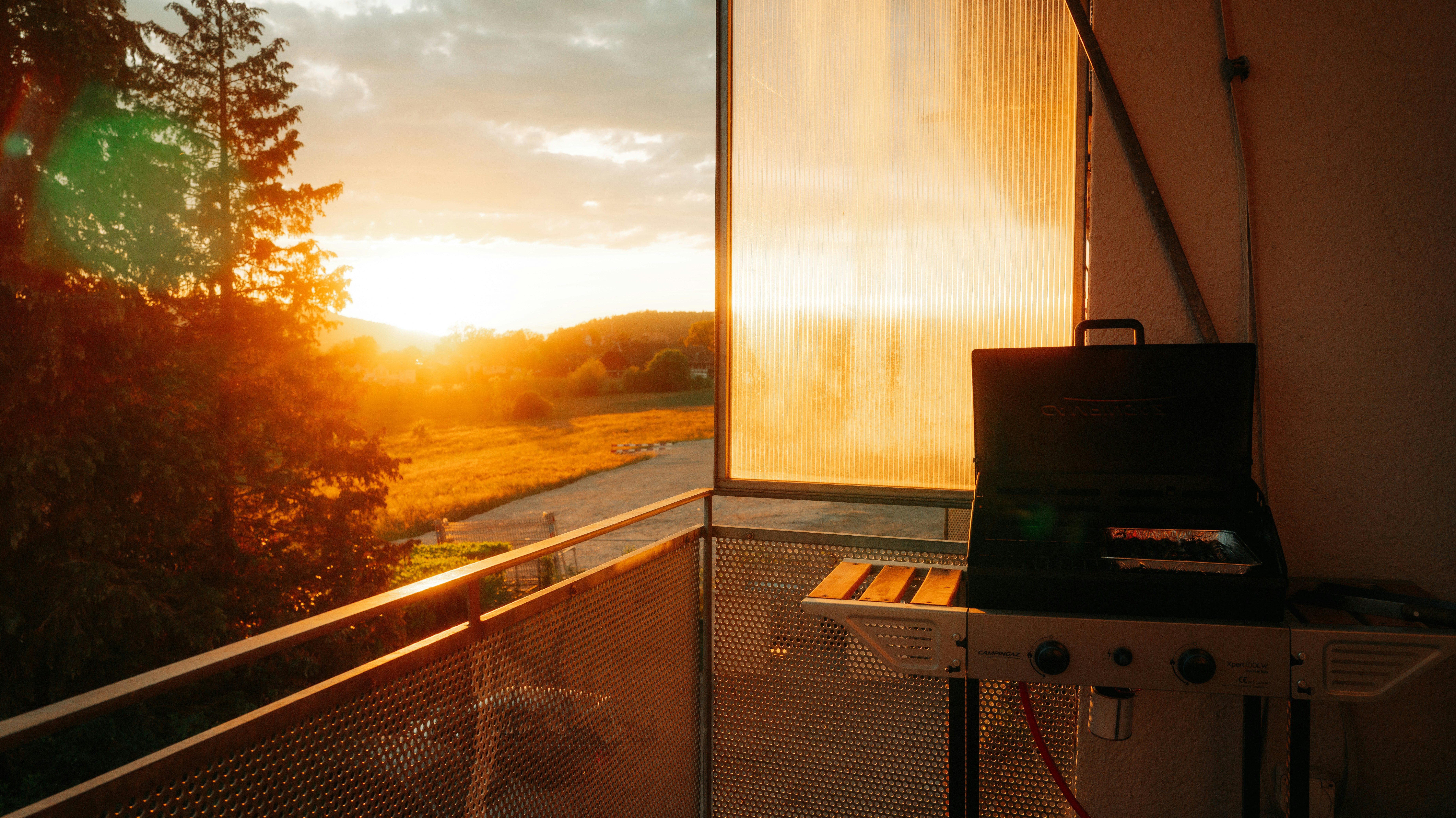 Sunset Balcony Grill: Warm Light on Steel and Smoke
