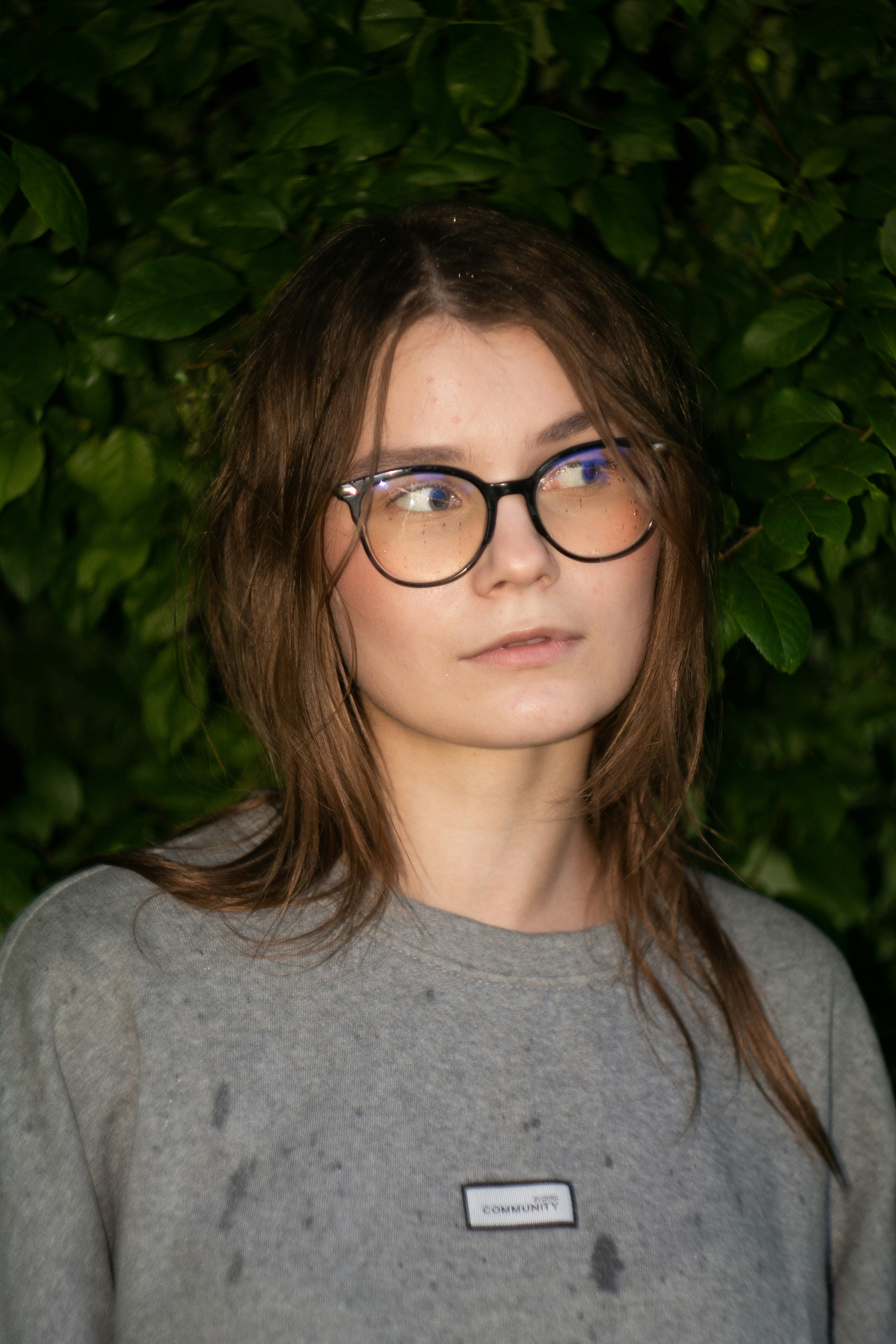 Glasses and Gaze: A Quiet Portrait in Nighttime Green