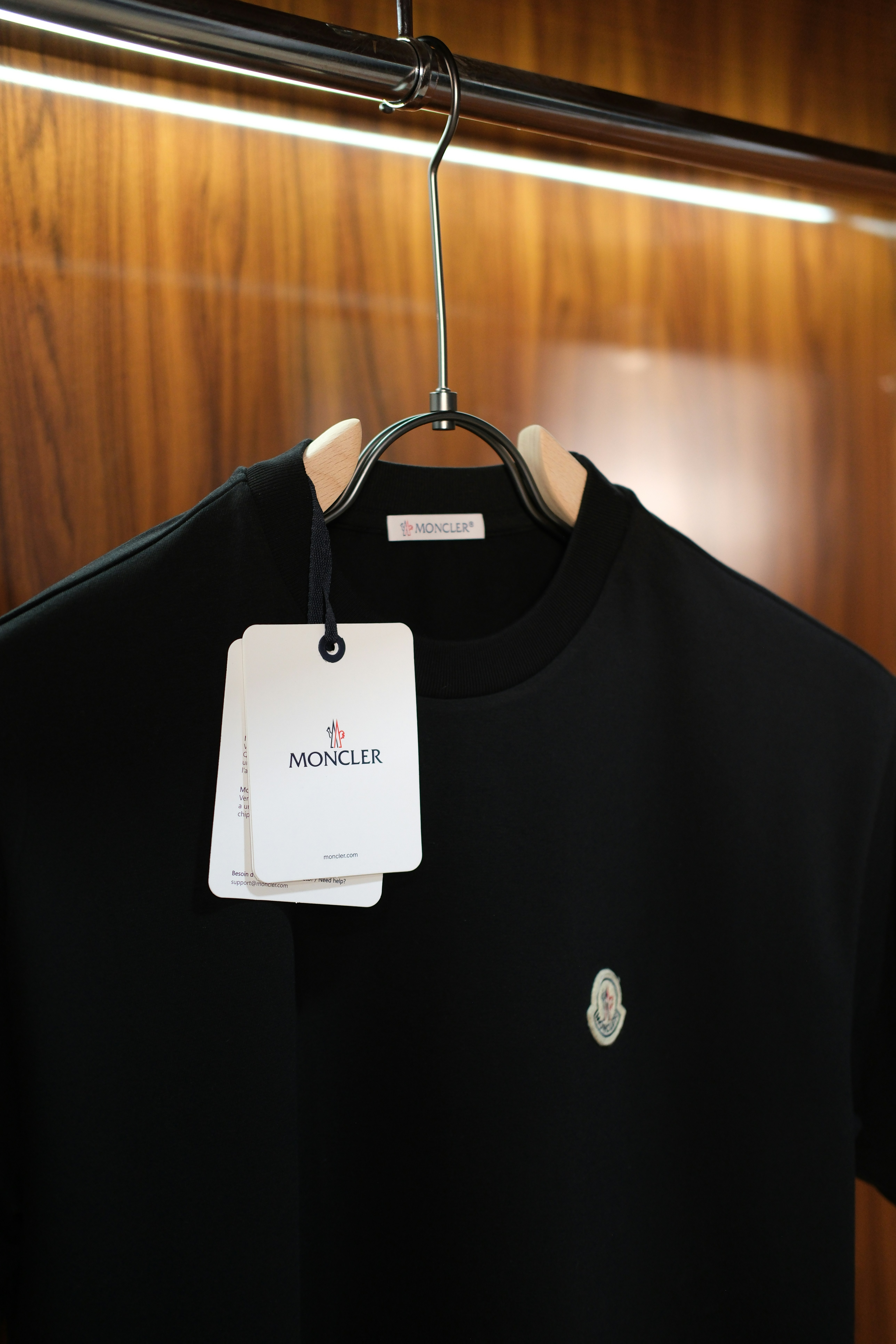 Moncler Hanger: A Minimalist Black T‑shirt on Display