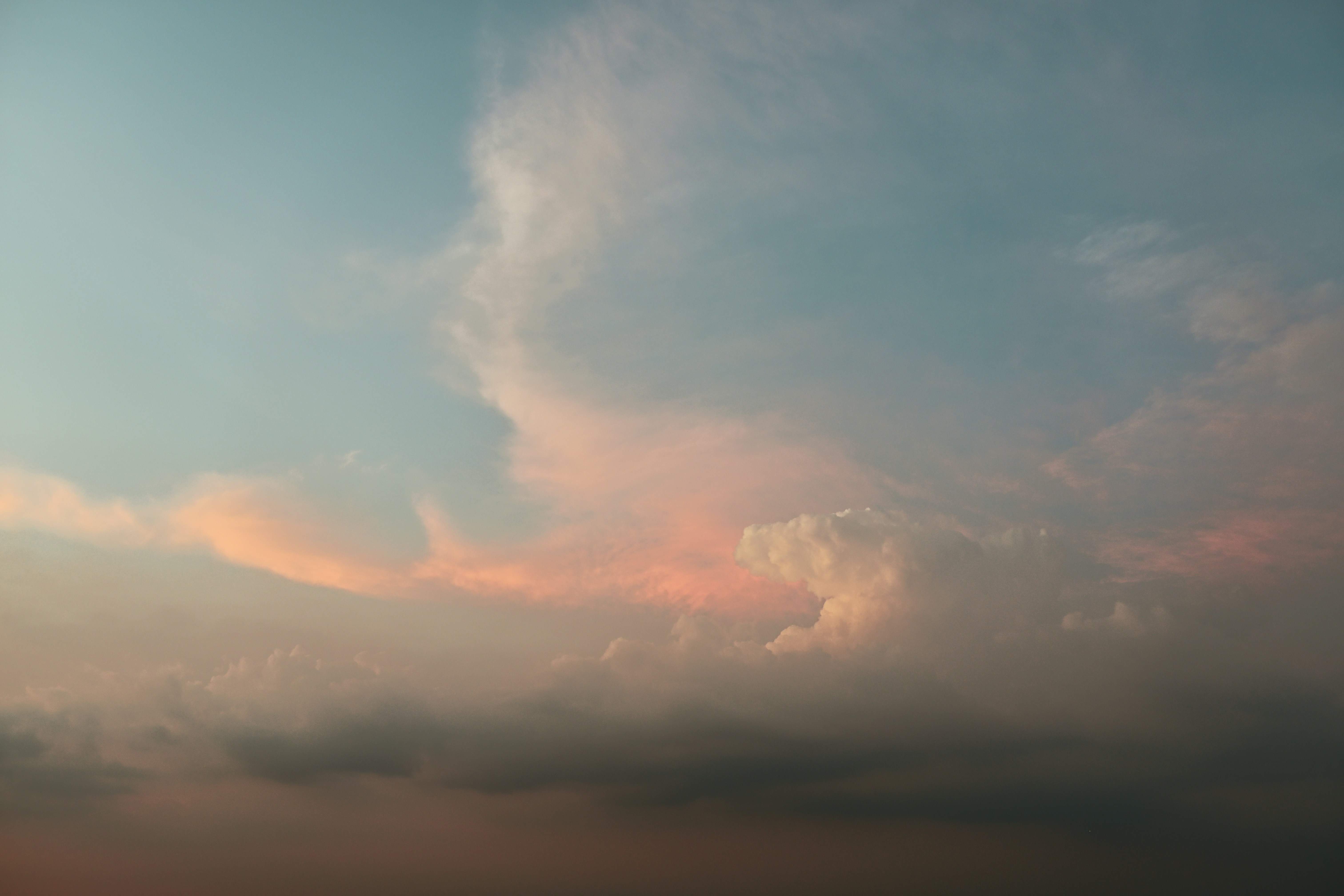 Vibrant clouds against a blue and pink sky.