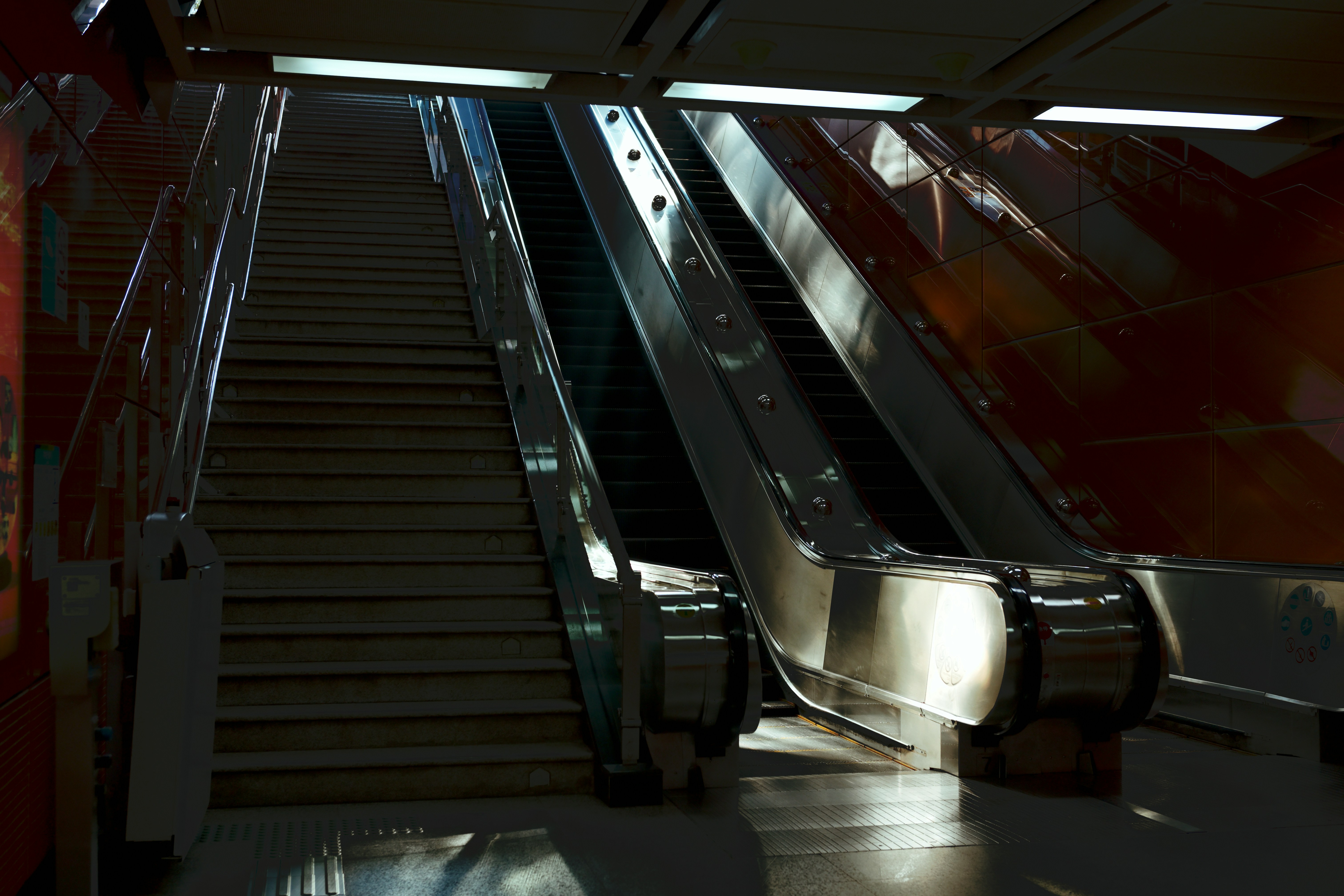 Shadowed Ascent: Escalators Amid Evening Haze