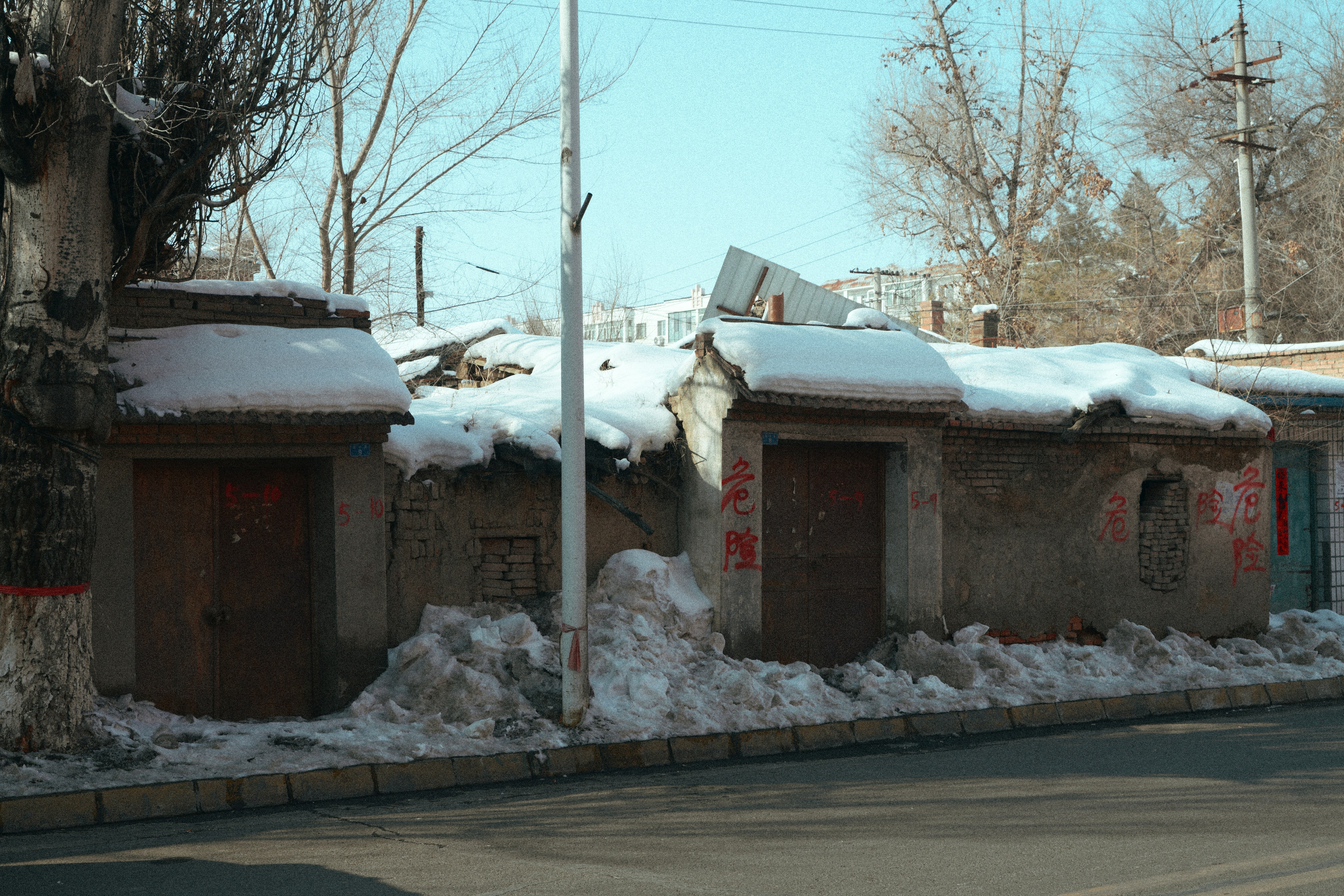 Snow-Capped Row of Stucco Homes Along a Quiet Street