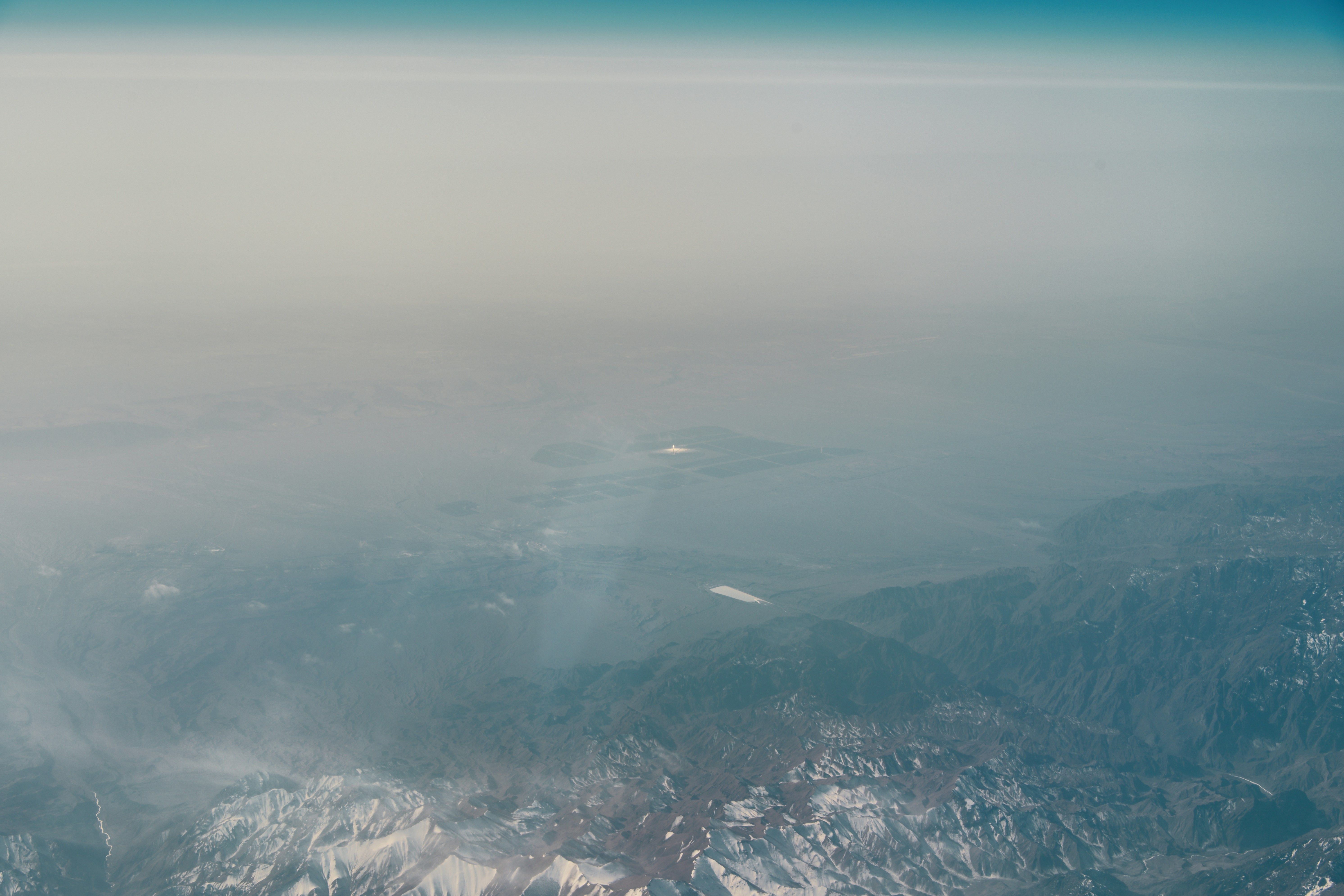 Aerial Veil over Snowy Peaks