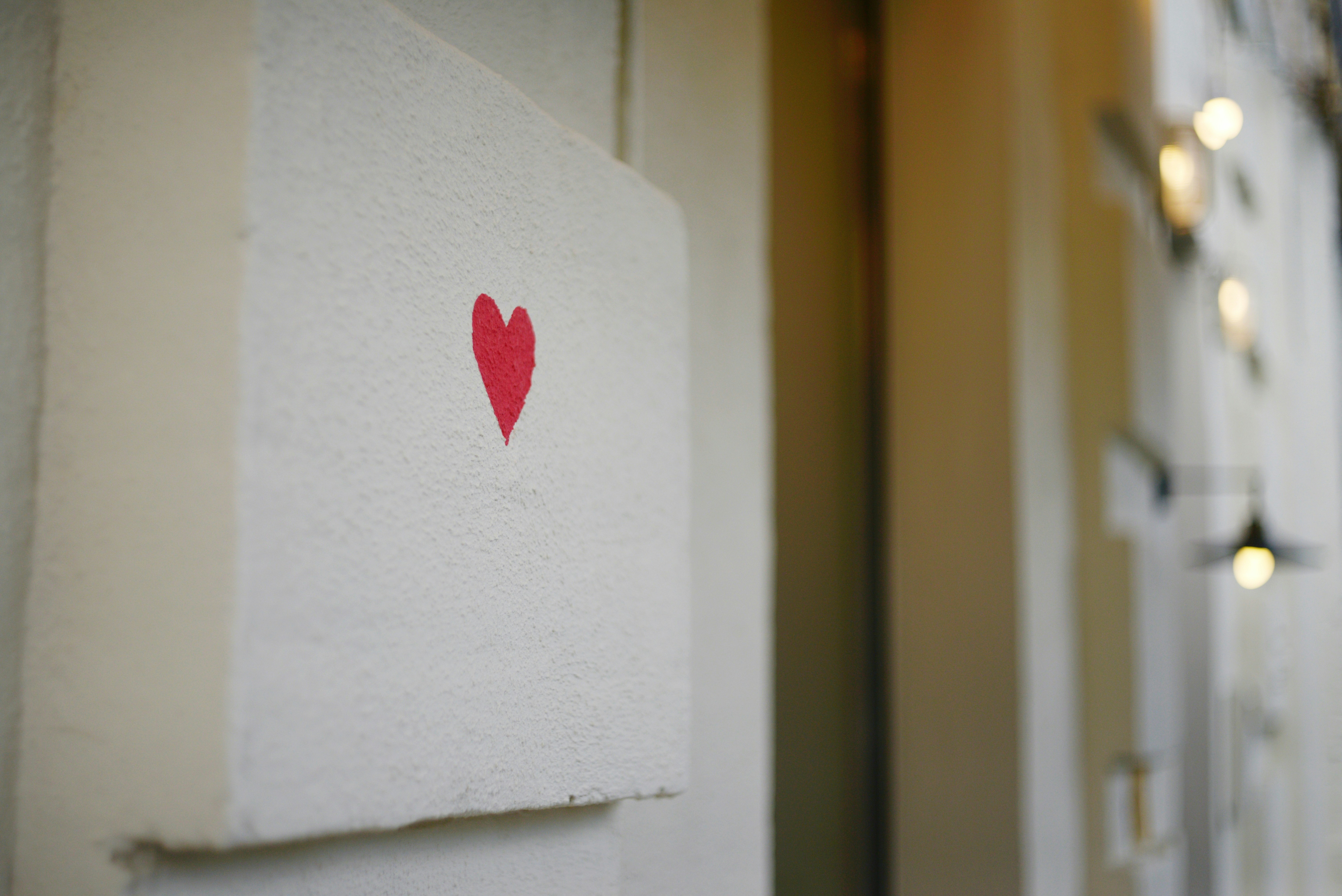Red Heart on a White Wall: Minimal Street Corner