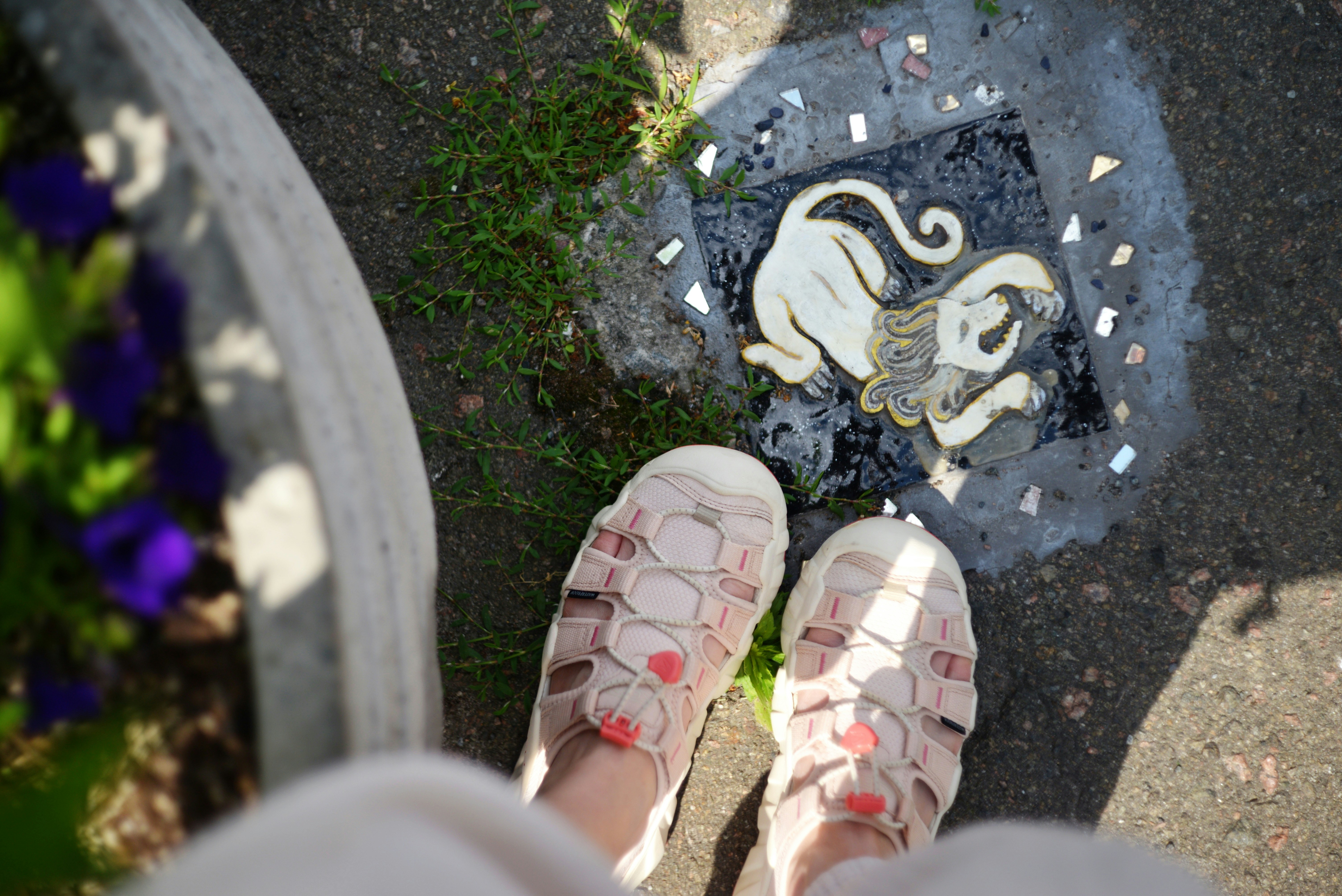 Footsteps Over Mosaic: A Ground-Level Moment with a Playful Shoe Path