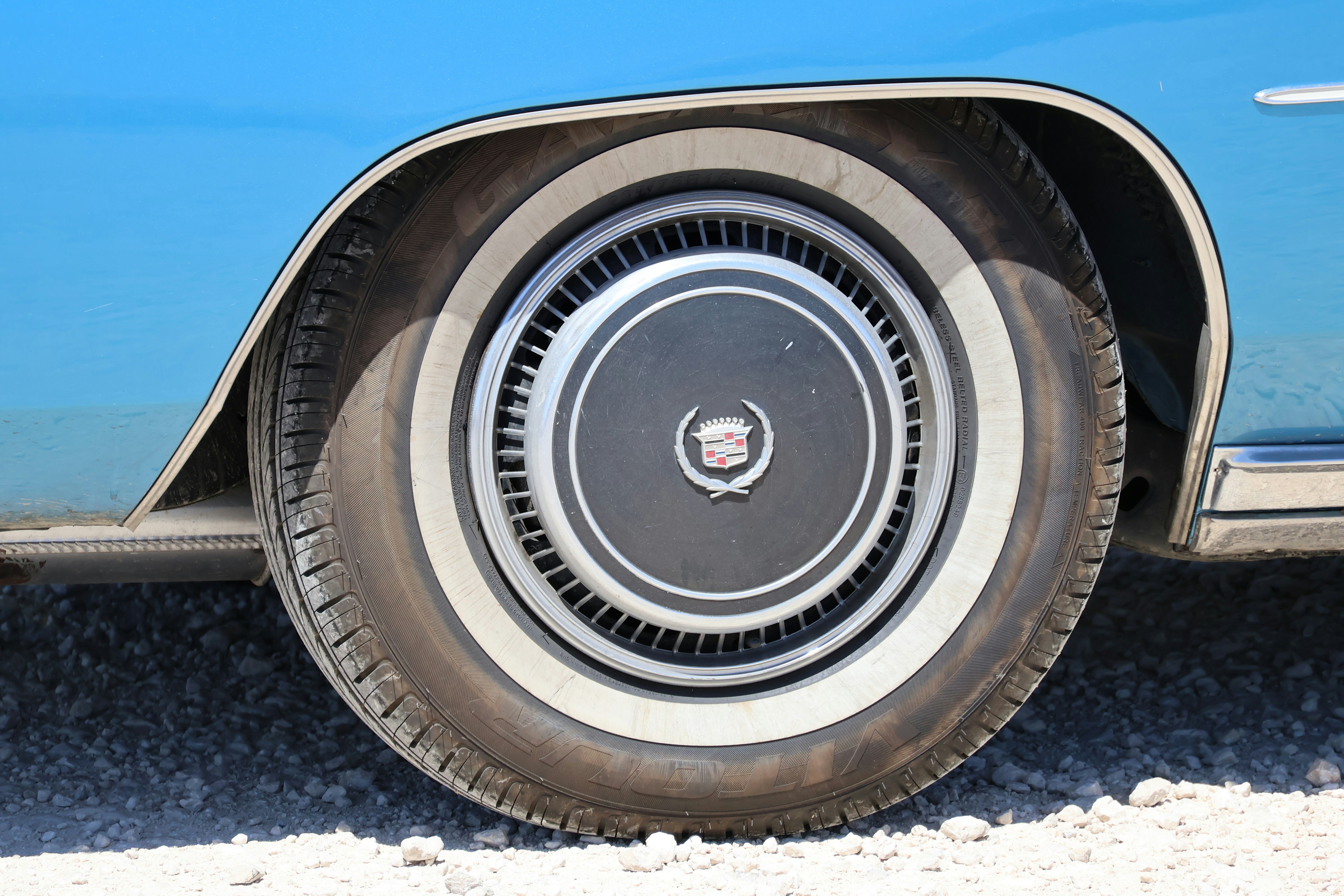 Blue Classic: Cadillac hubcap and tire undercarriage at rest