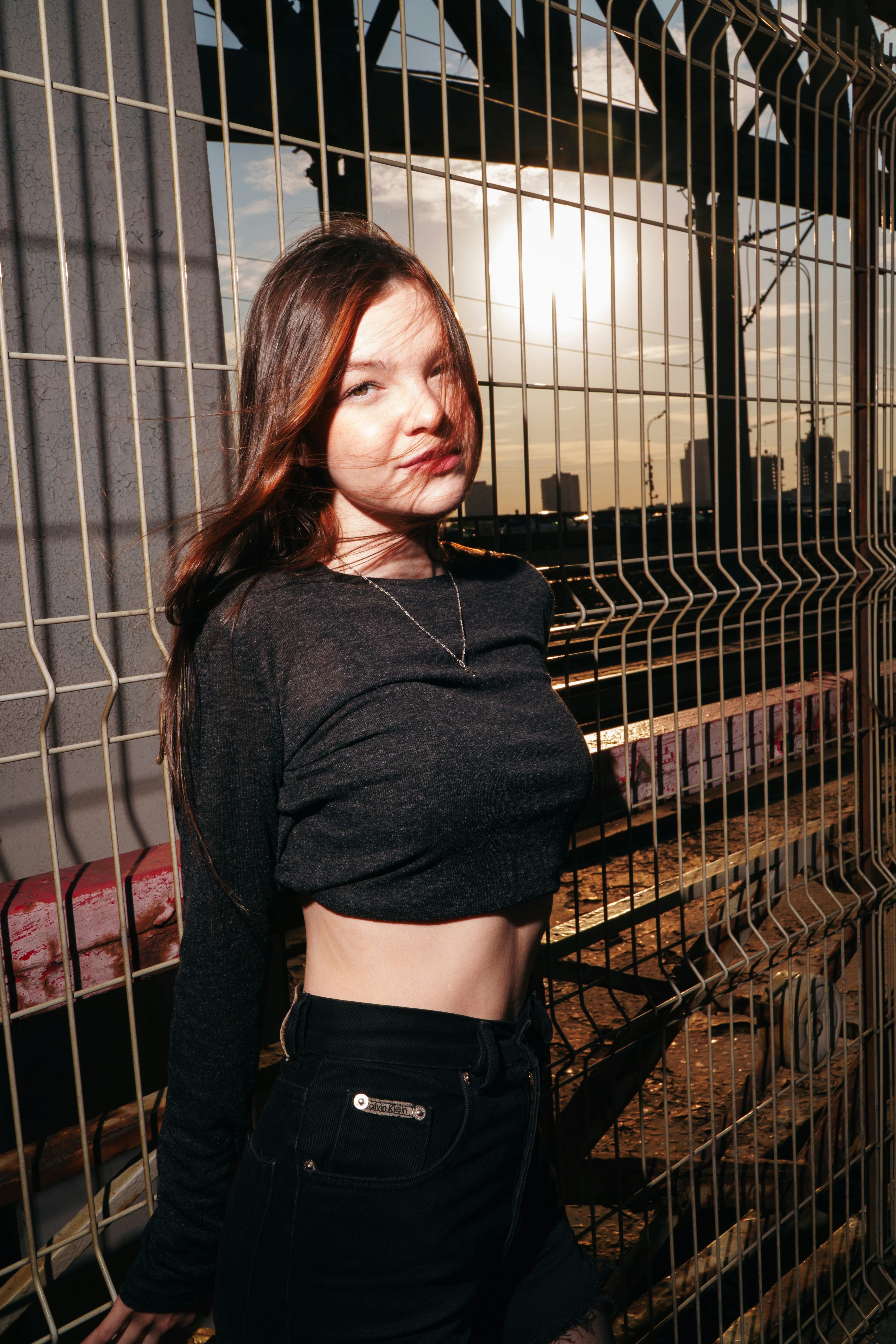 Cityscape Sunset Portrait Through a Metal Grid
