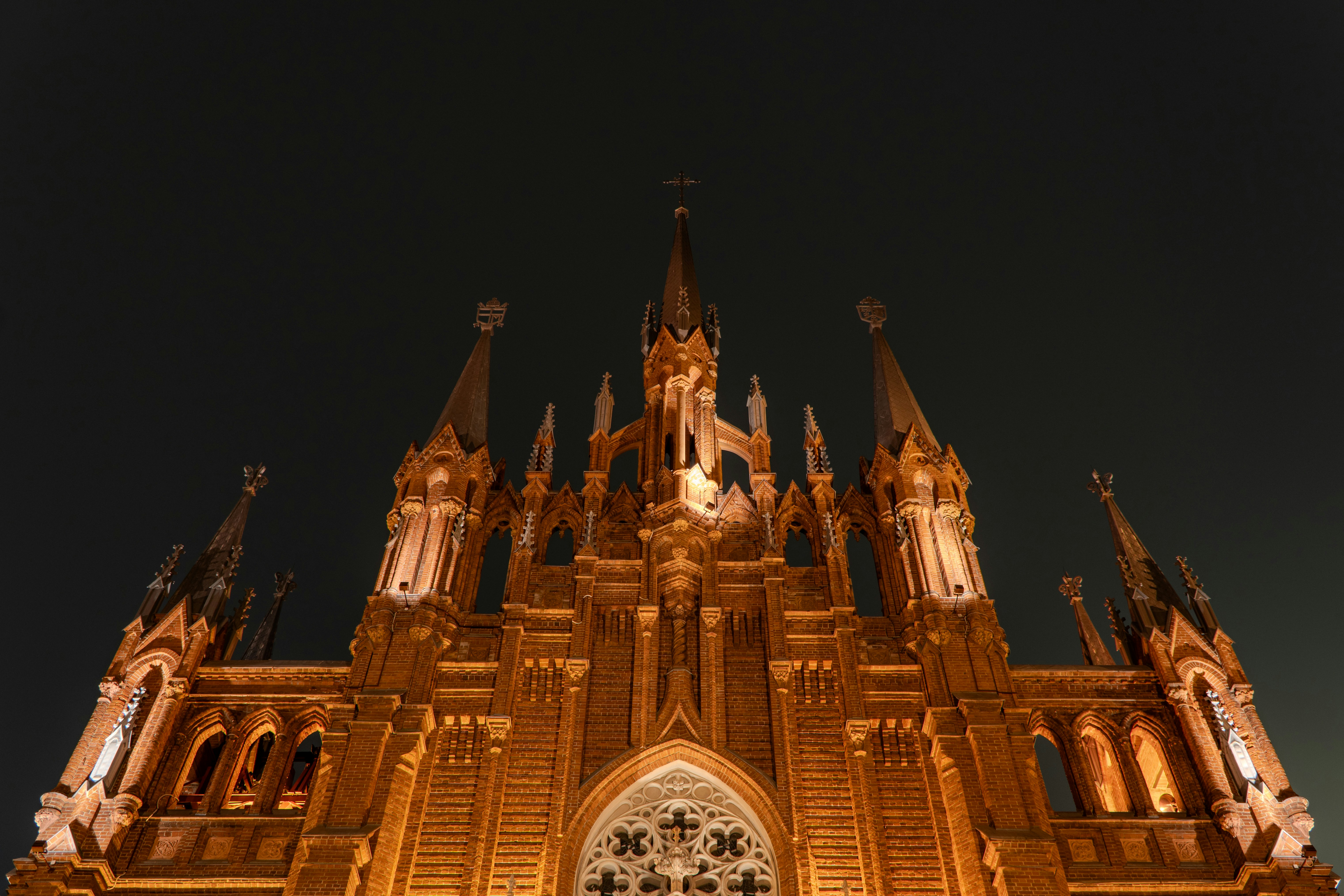 Gothic Cathedral Facade Illuminated Against Night Sky