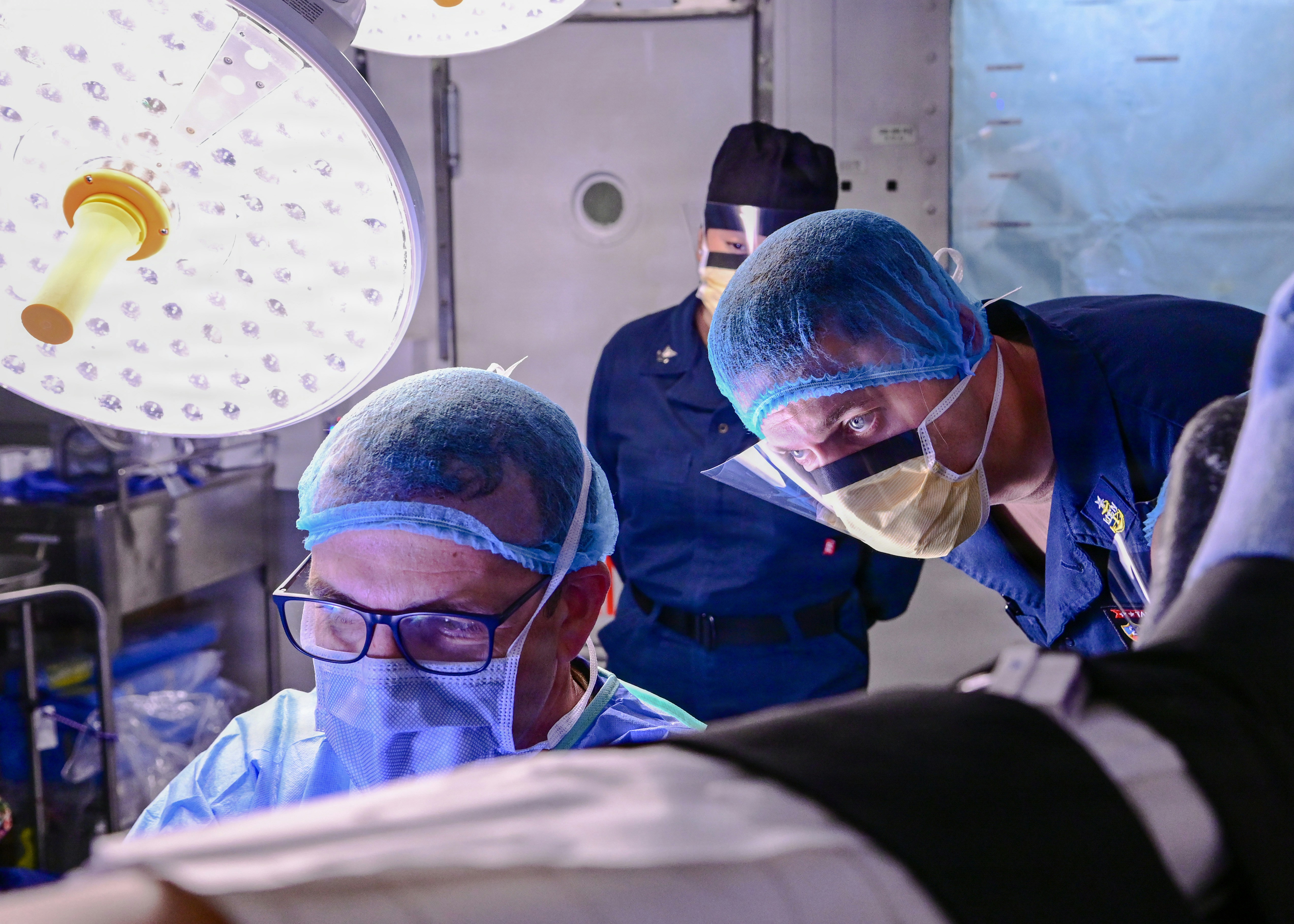 U.S. Navy Lt. Cmdr. James O'Loughlin, left, assigned to Fleet Surgical Team (FST) 5, and Senior Chief Hospital Corpsman William Meyers, assigned to Wasp-class amphibious assault ship USS Essex (LHD 2), perform a routine surgery while underway, June 10, 2026. Essex is underway in the U.S. 3rd Fleet area of operations. An integral part of the U.S. Pacific Fleet, U.S. 3rd Fleet leads naval forces in the Indo-Pacific and provides the realistic, relevant training necessary to execute the U.S. Navy's role across the full spectrum of military operations. U.S. 3rd Fleet works together with allies and partners to advance freedom of navigation and overflight, the rule of law and other principles that underpin security for the Indo-Pacific region. (U.S. Navy photo by Mass Communication Specialist Seaman Ivan A. Garcia)