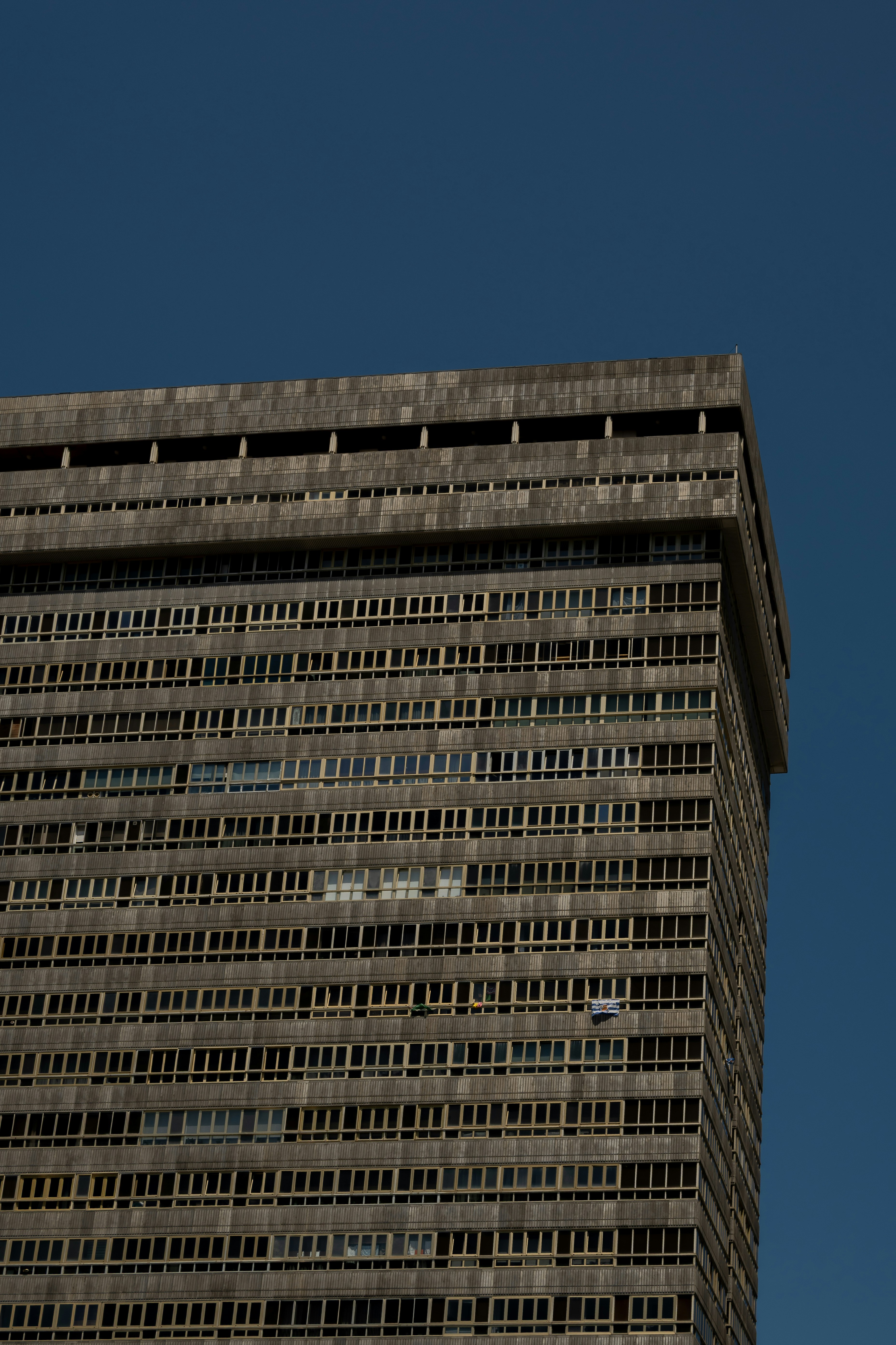 Concrete tiered facade under a clear blue sky