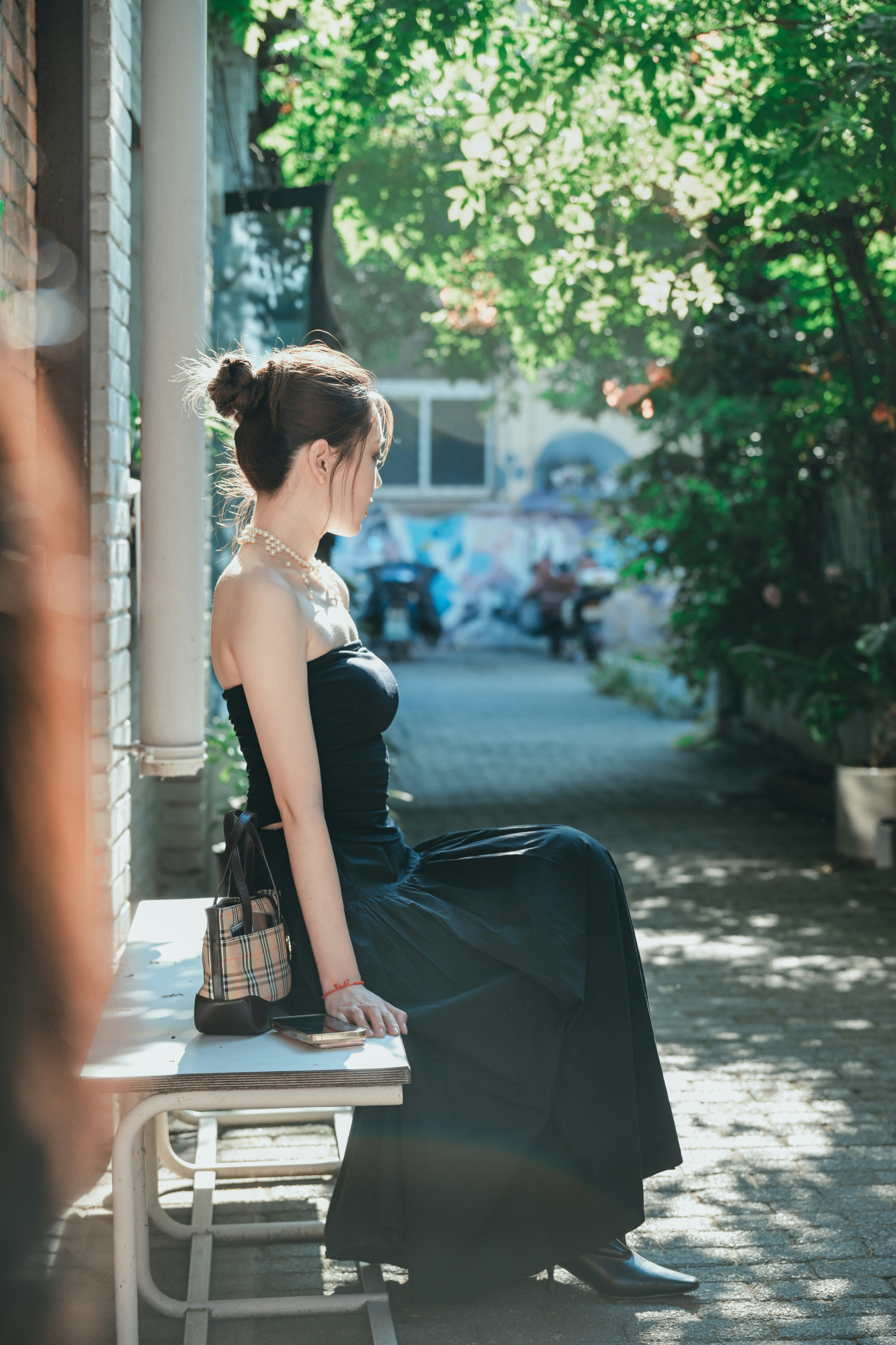 Quiet Portrait on a Sunlit City Path