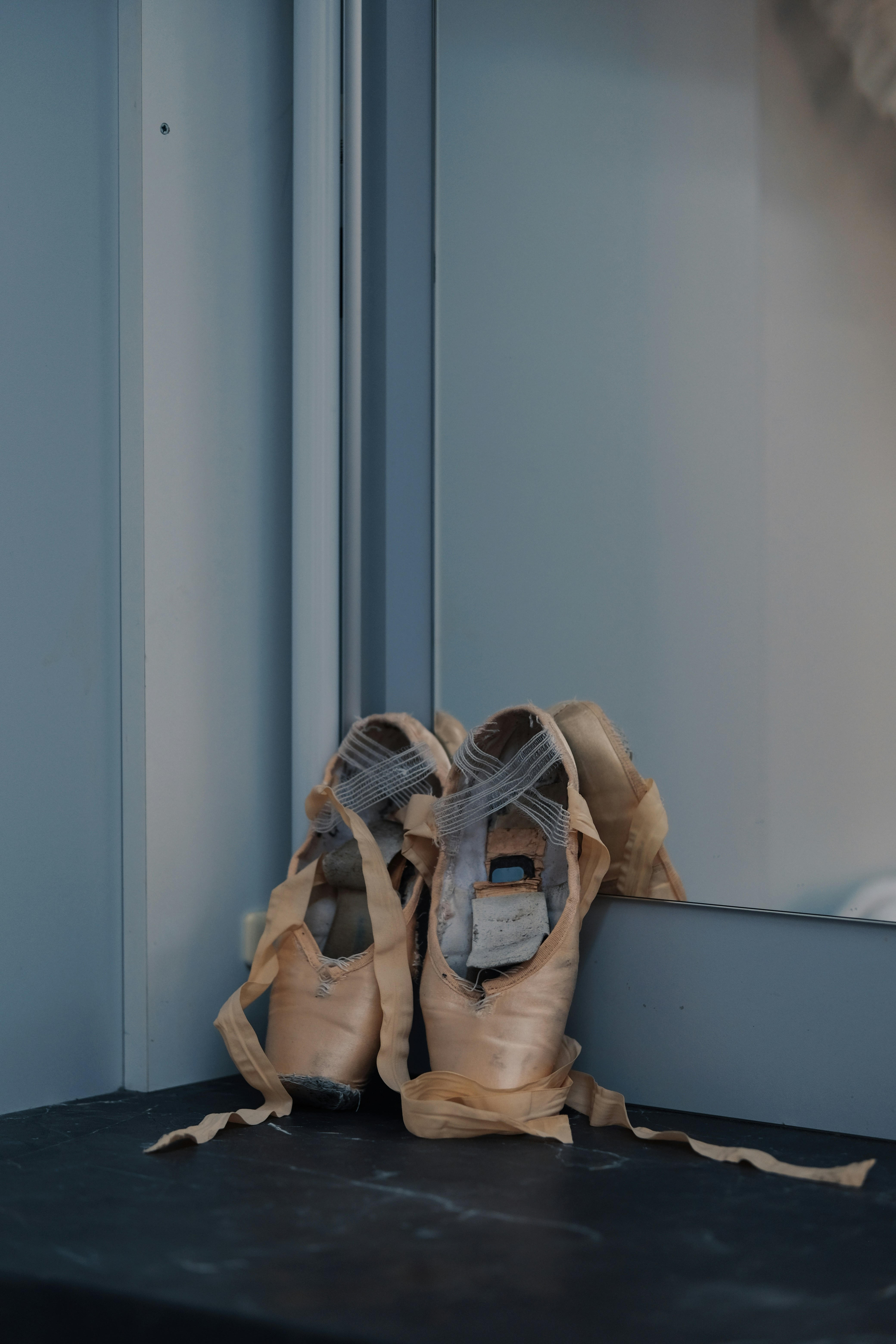 Ballet Slippers Rest in Quiet Corner by Mirror