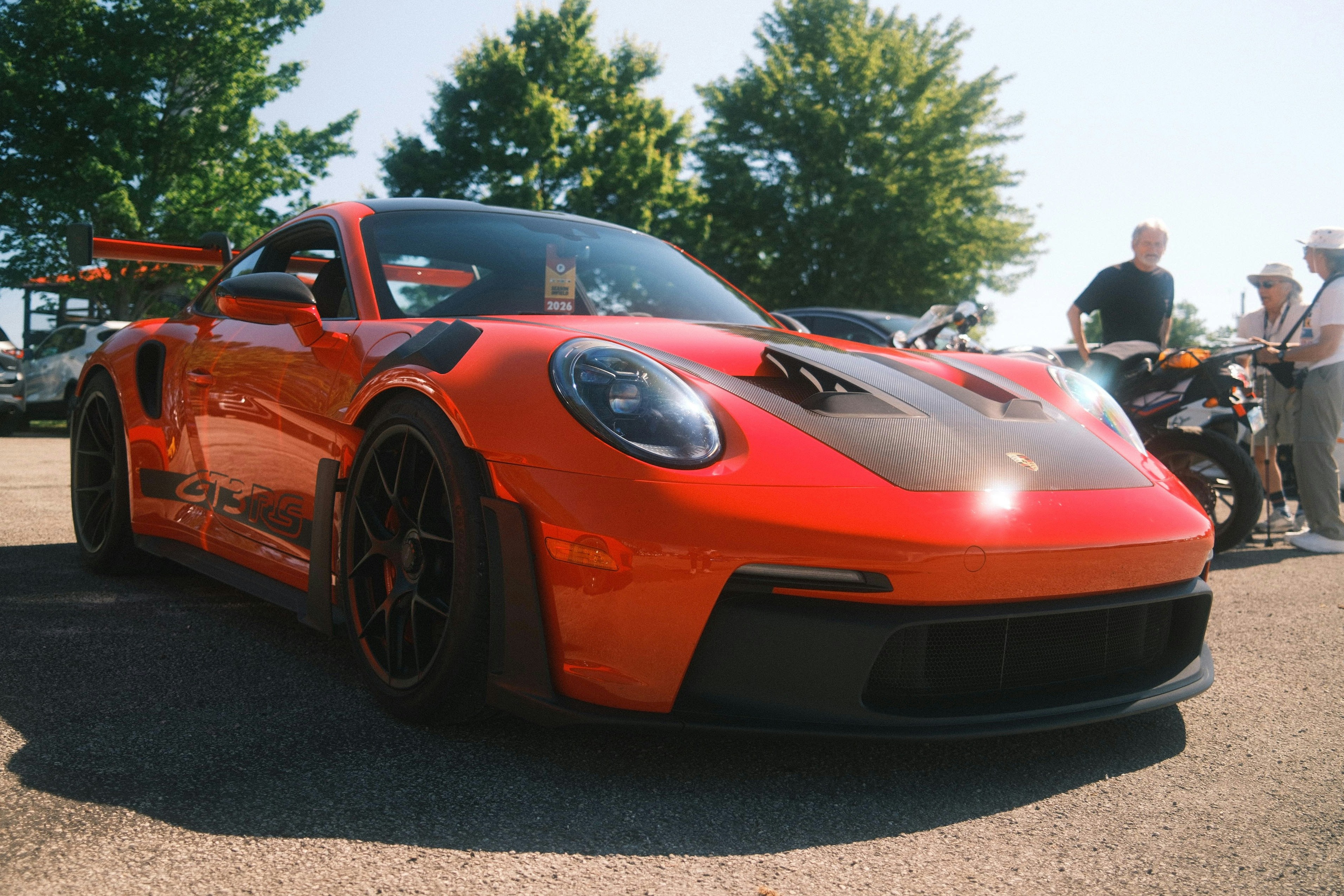 Orange Porsche Stands Bold Among Onlookers at Car Meet