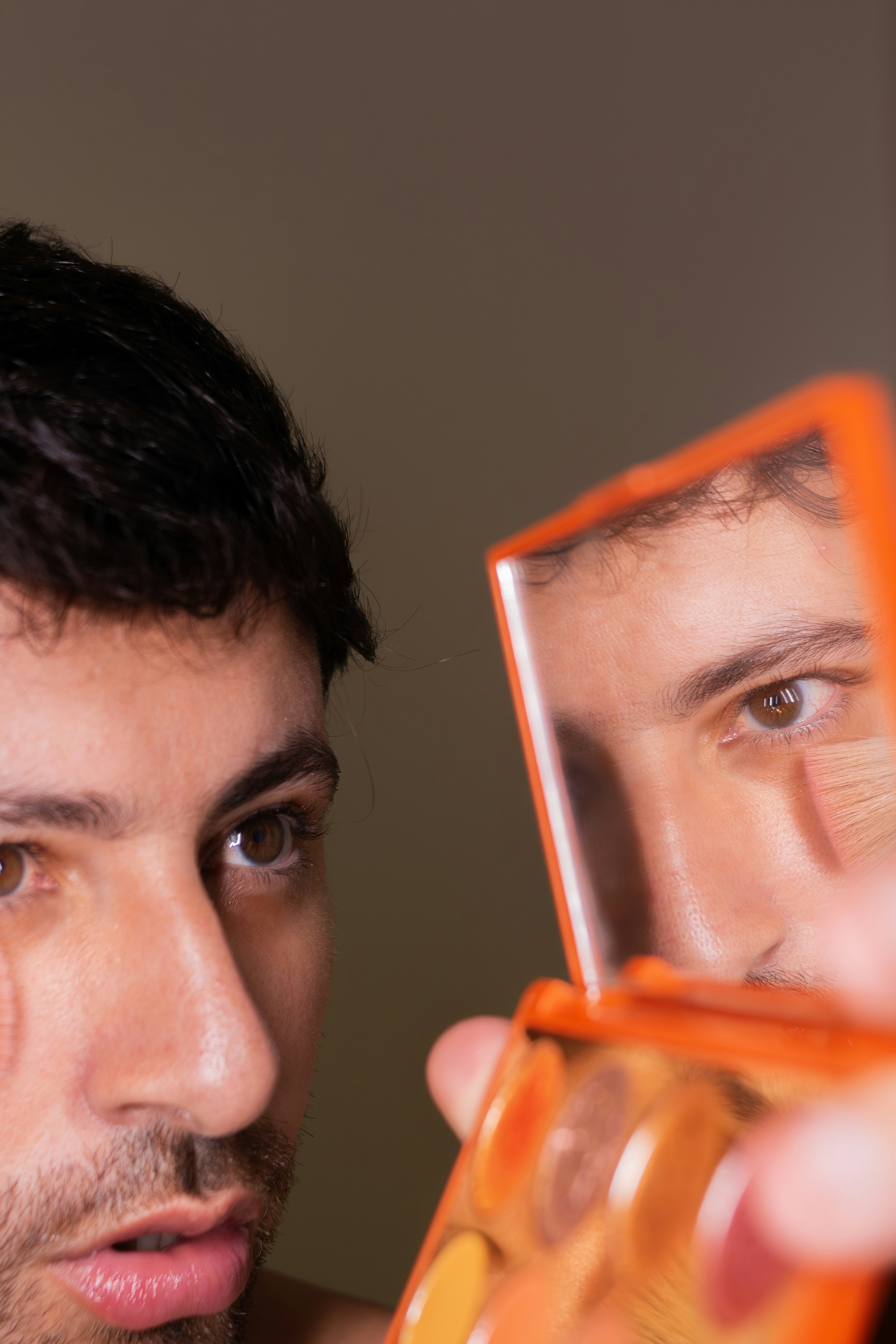 Mirrored Gaze: A Dual View in Orange Frame