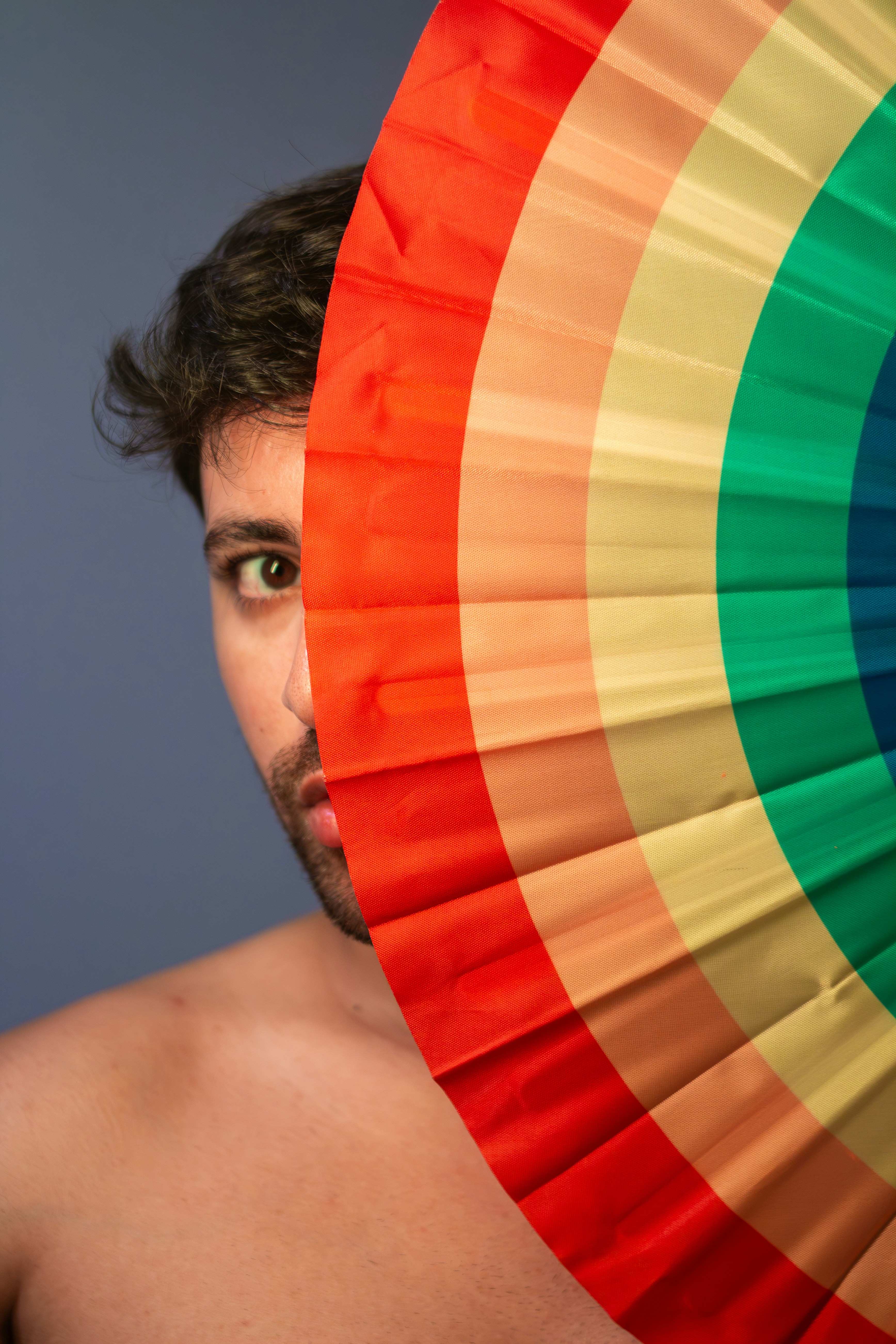 Partial Portrait: A Face Revealed Behind a Rainbow Wheel