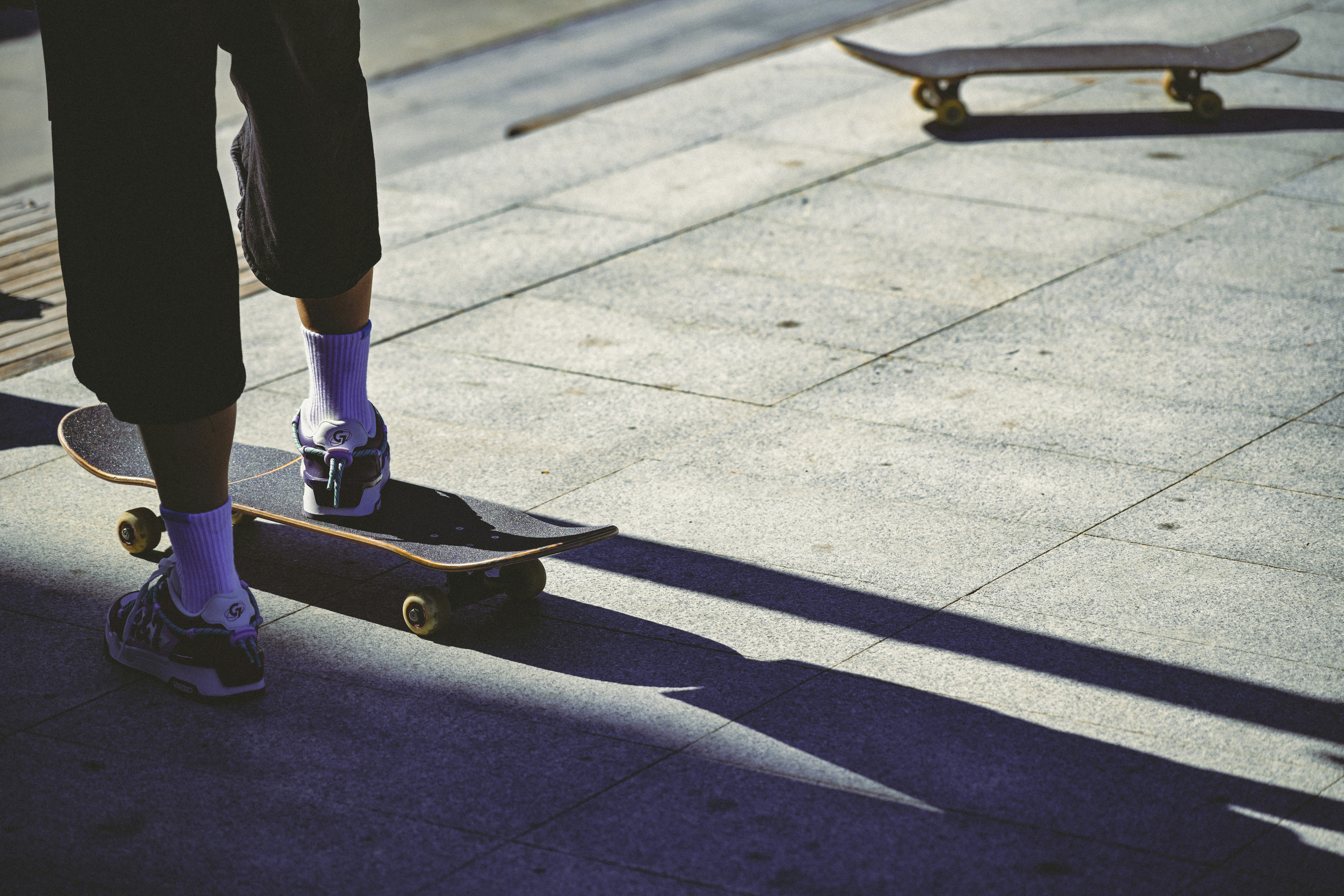Balanced Stance: A Skateboarder's Shadow and Sole
