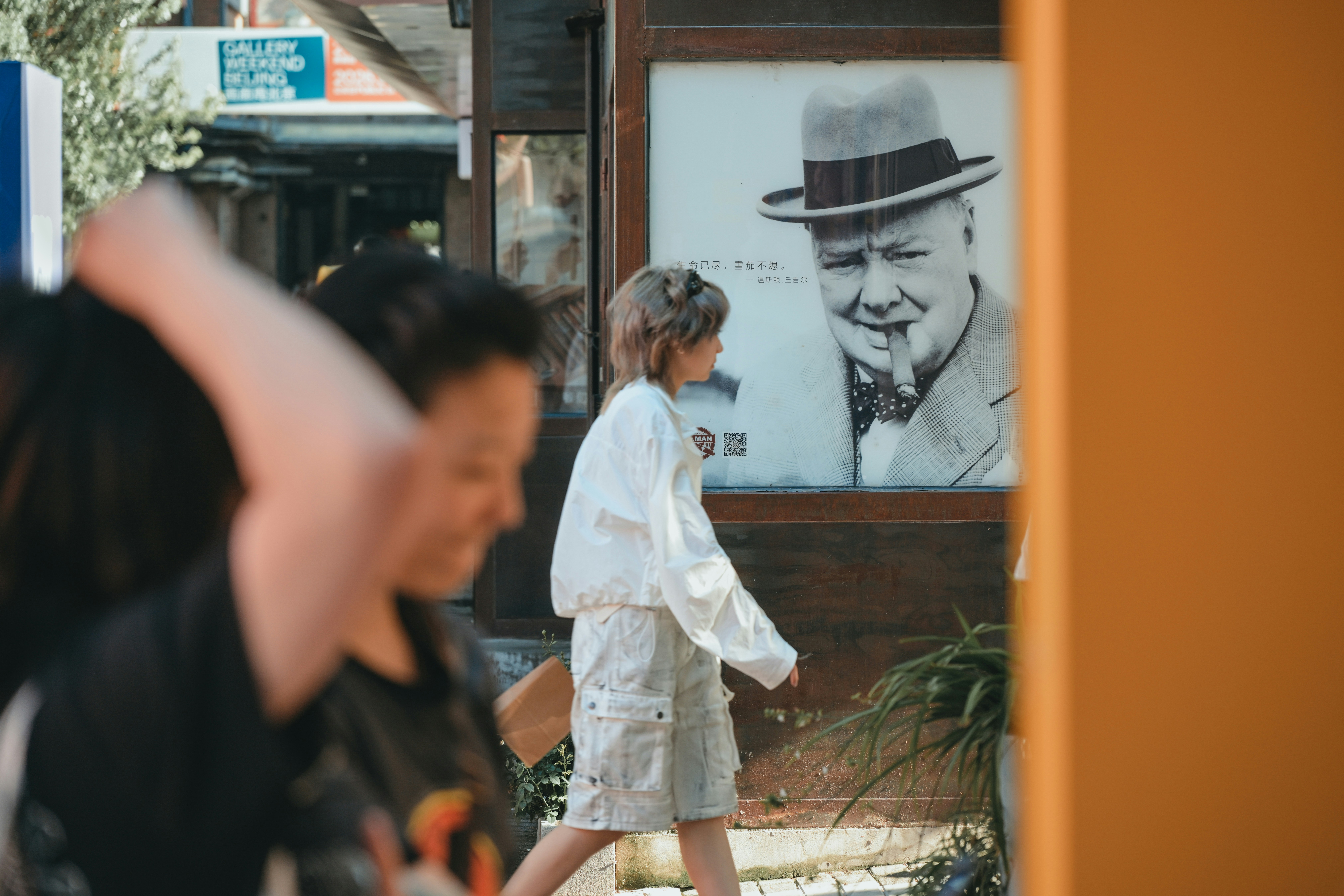 Passing Frame: A Quiet Moment in Front of a Timeless Portrait