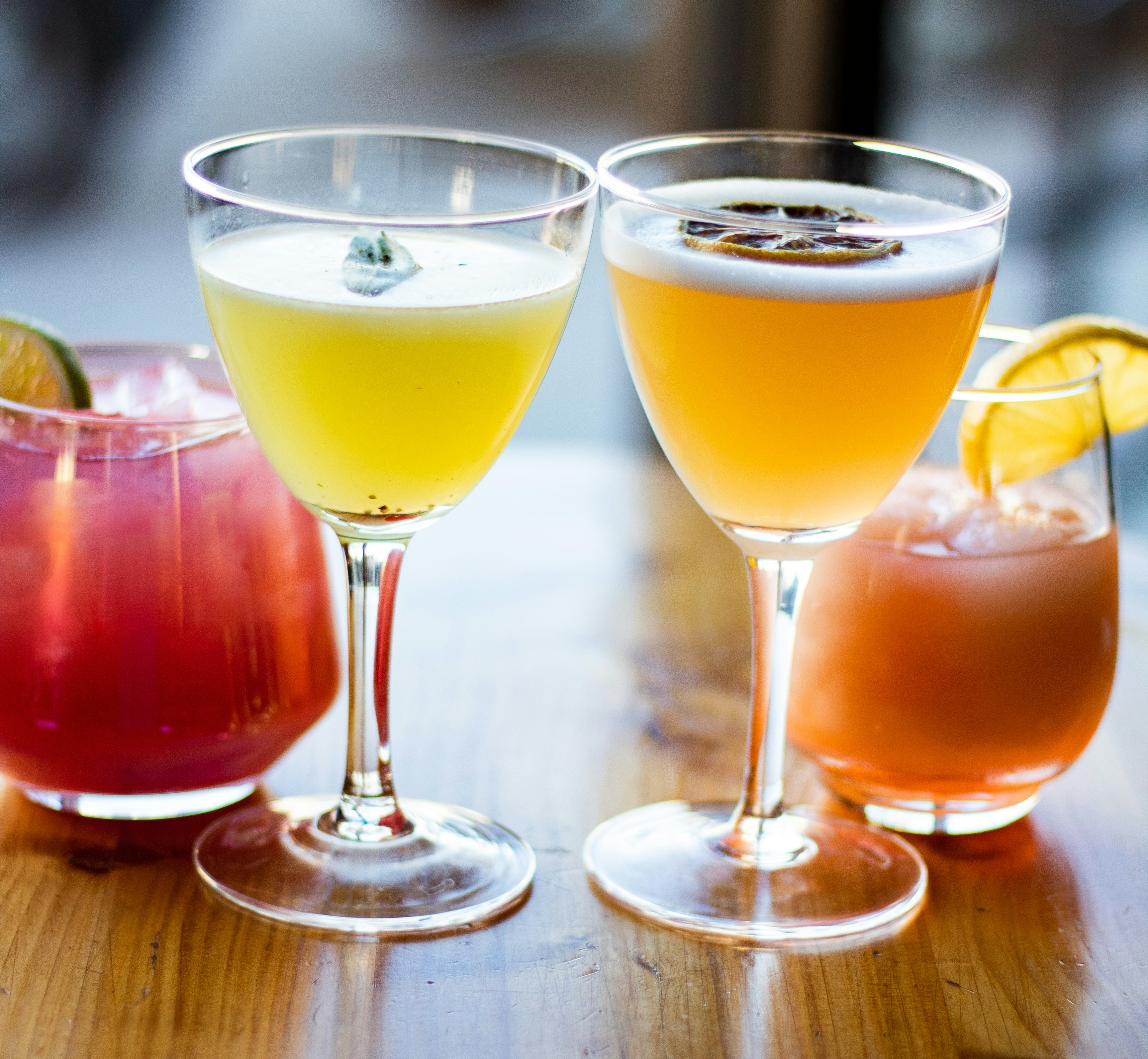 Sunlit Cheers: Trio of Glasses on a Warm Bar Top