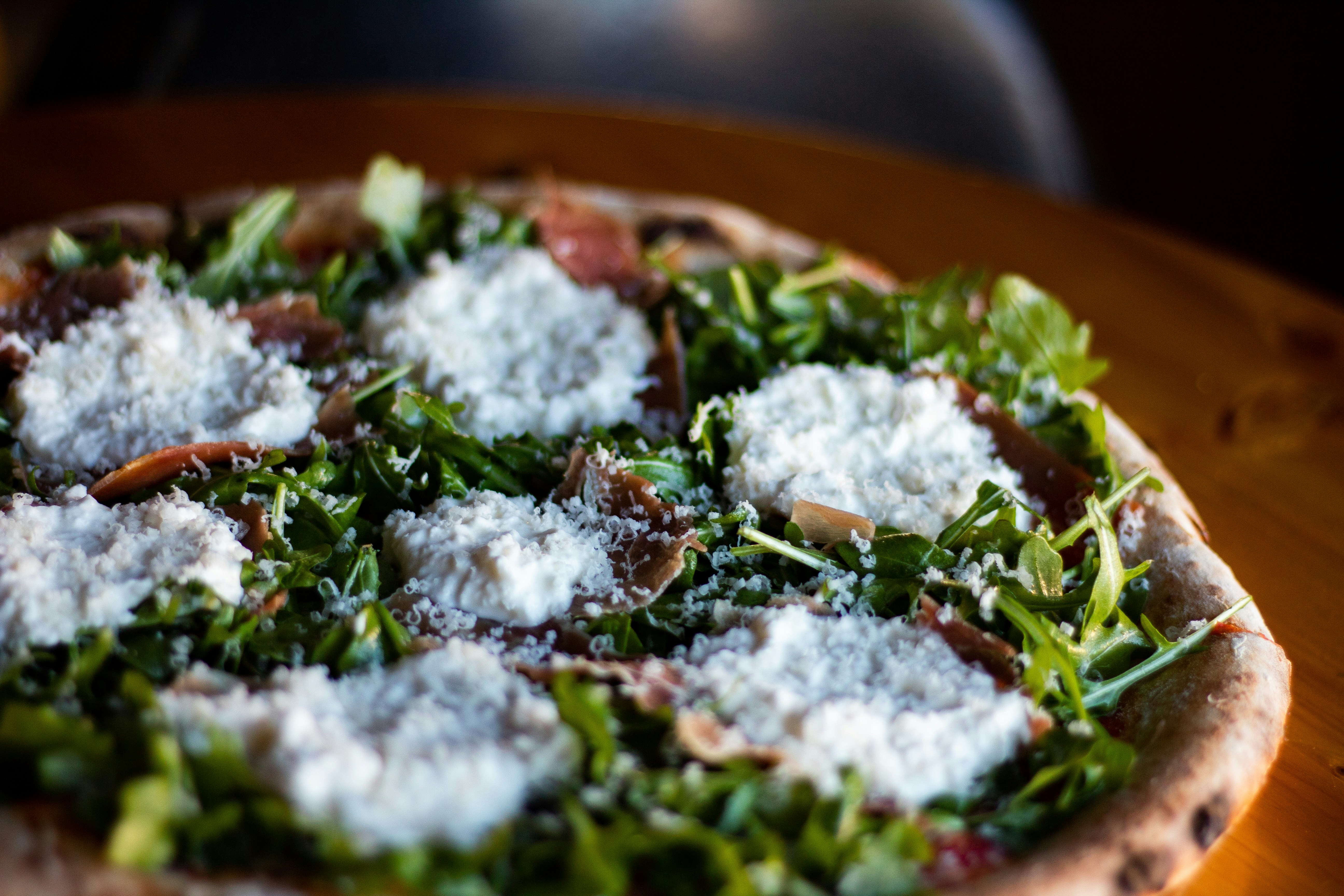 Herbal Cream Pizza with Snowy Gilded Toppings in a Rustic Setting