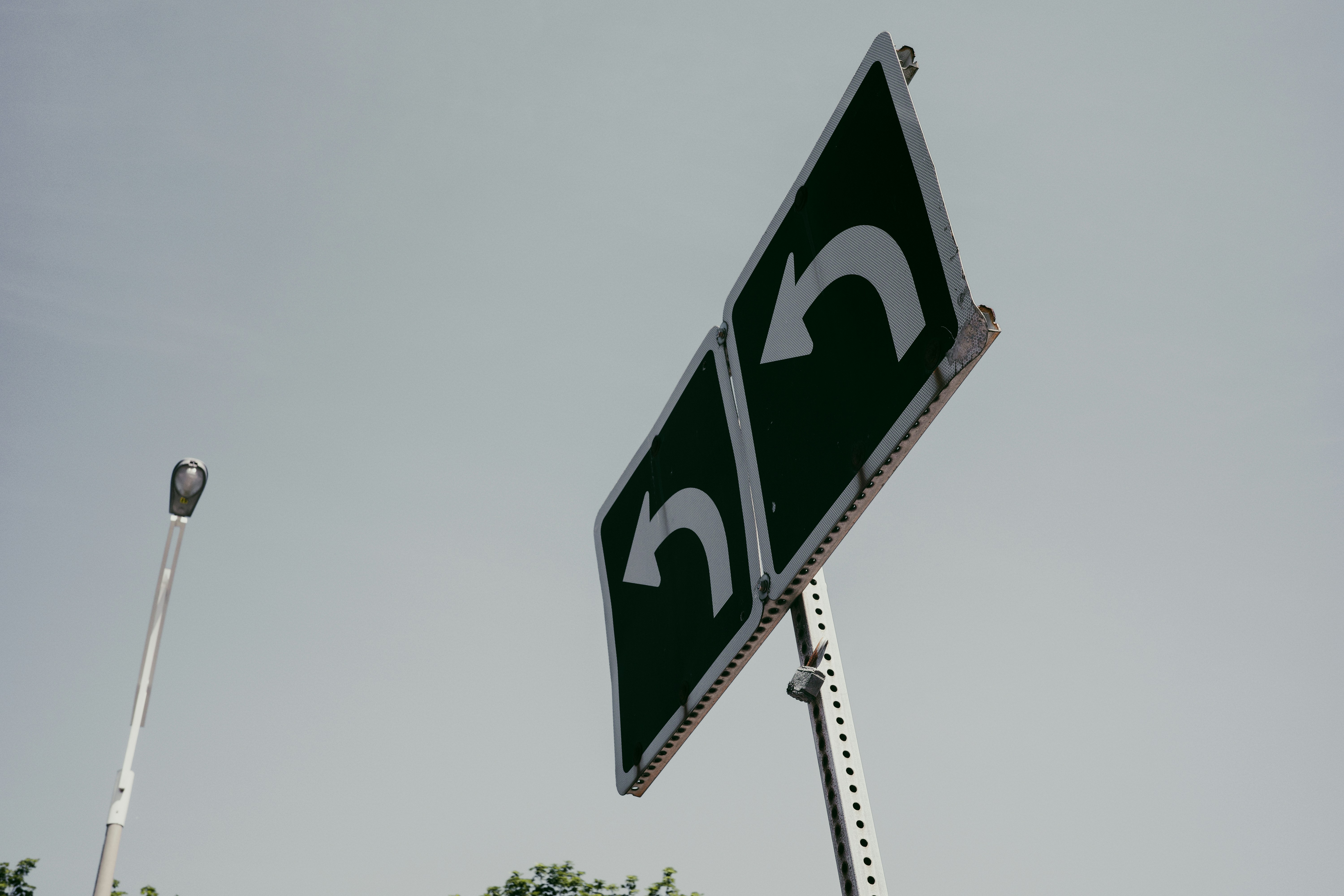 Nearing the Bend: A Signpost Rides the Sky