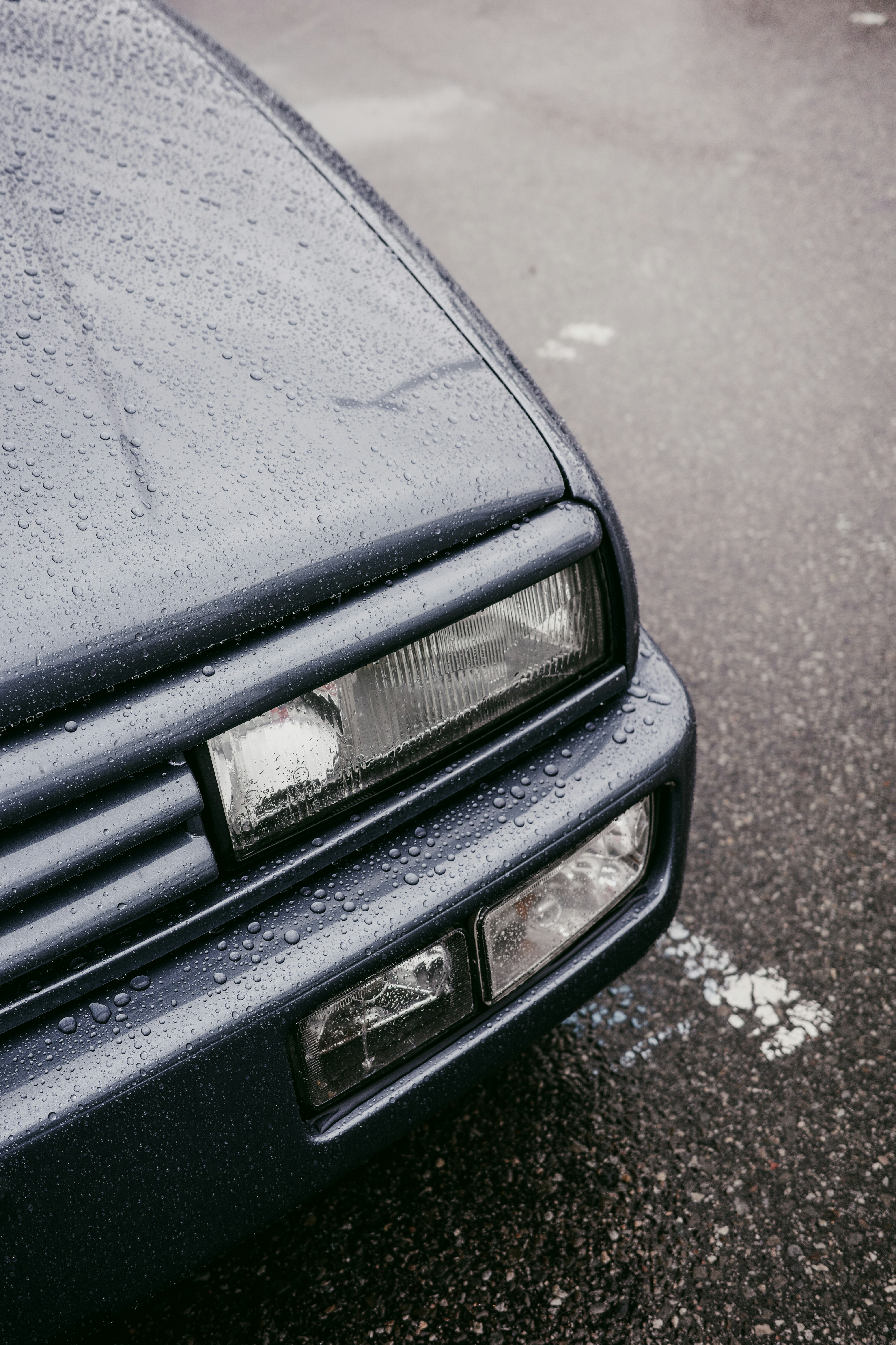 Rain-kissed Grille: A Quiet Close-up of a Car Front