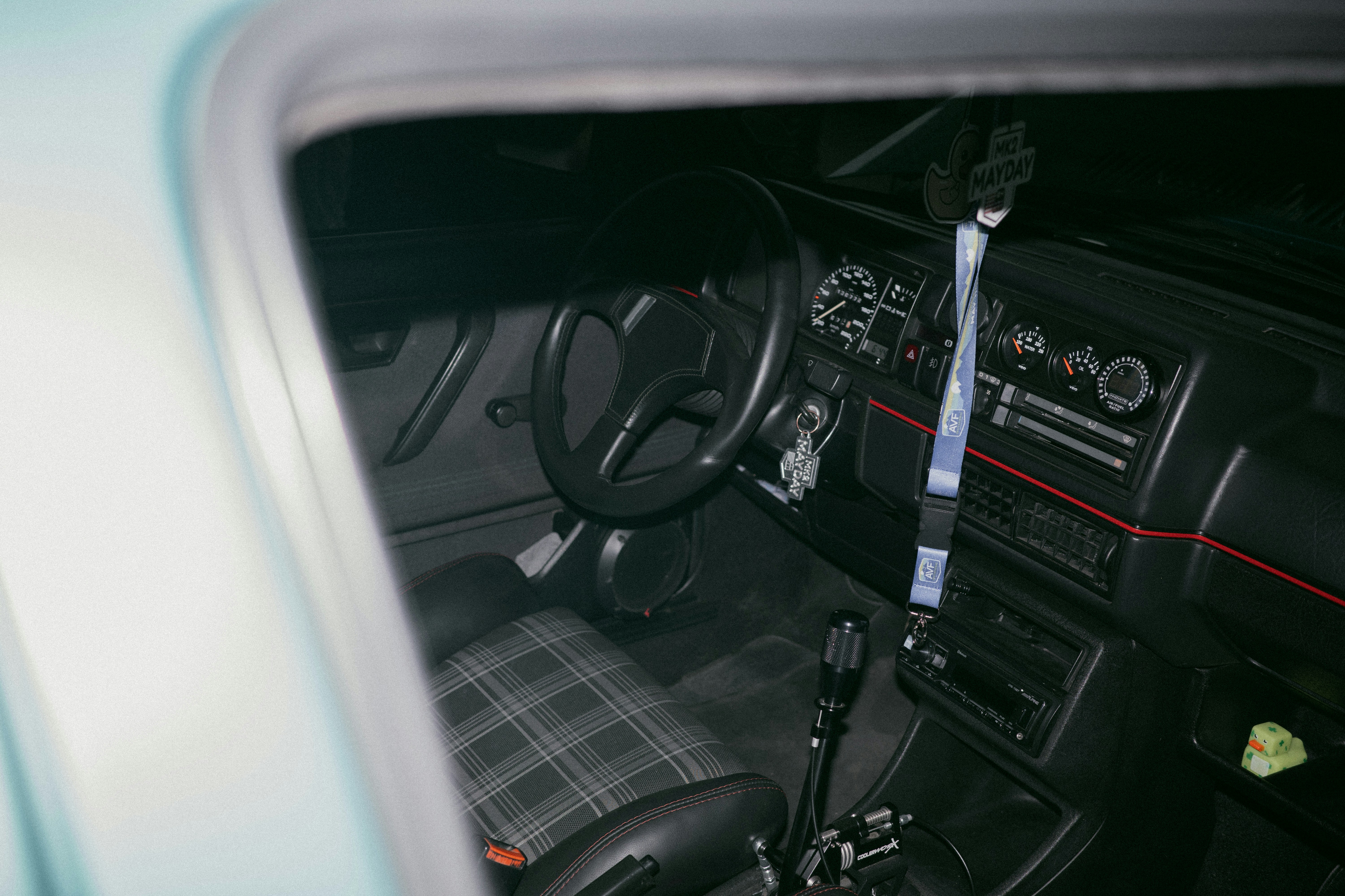 Cozy Car Cab Interior: A Vintage Grip with Plaid Seat and Lanyard