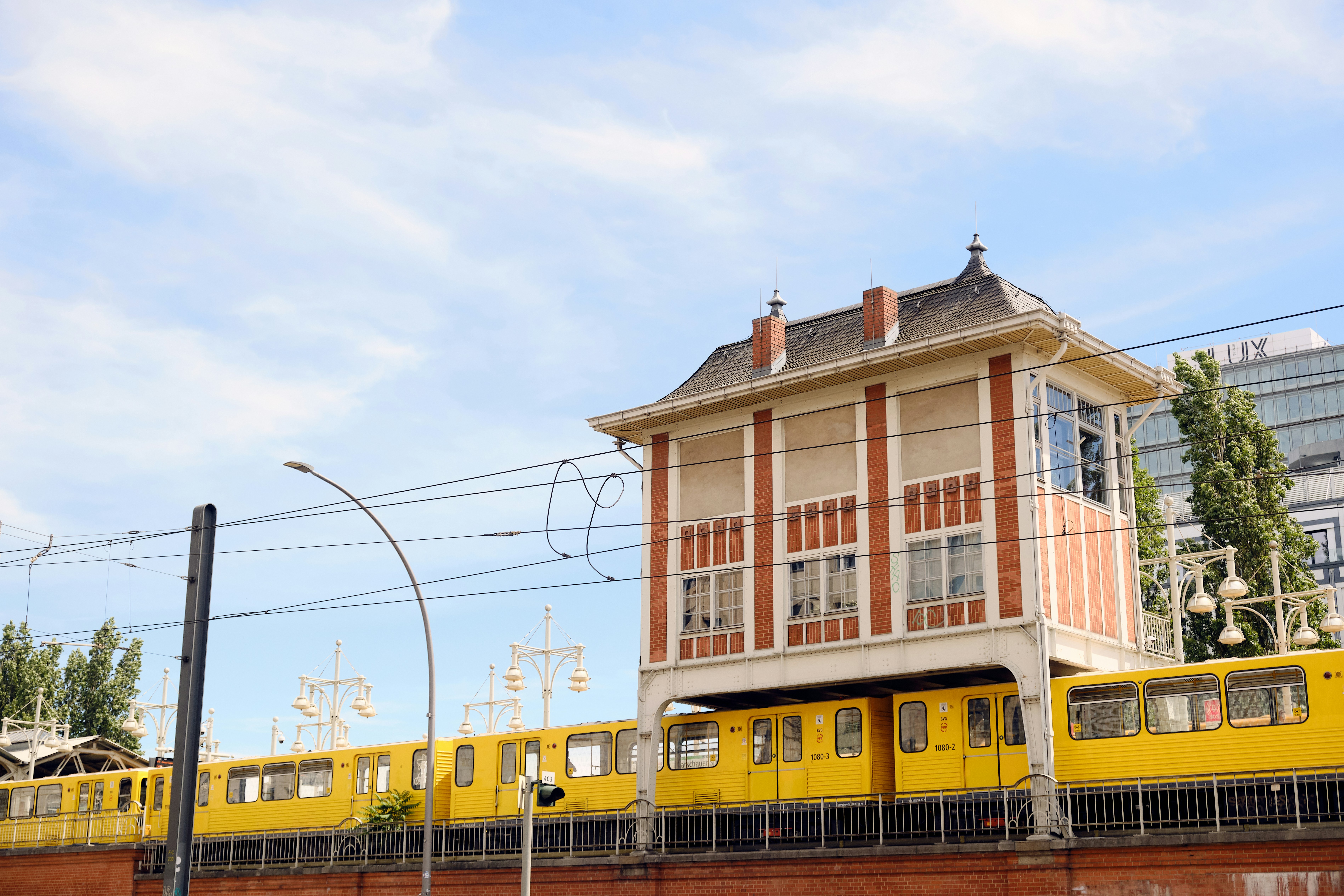 Yellow Rails at Dawn: A Station House Overlooking a Bright Corridor