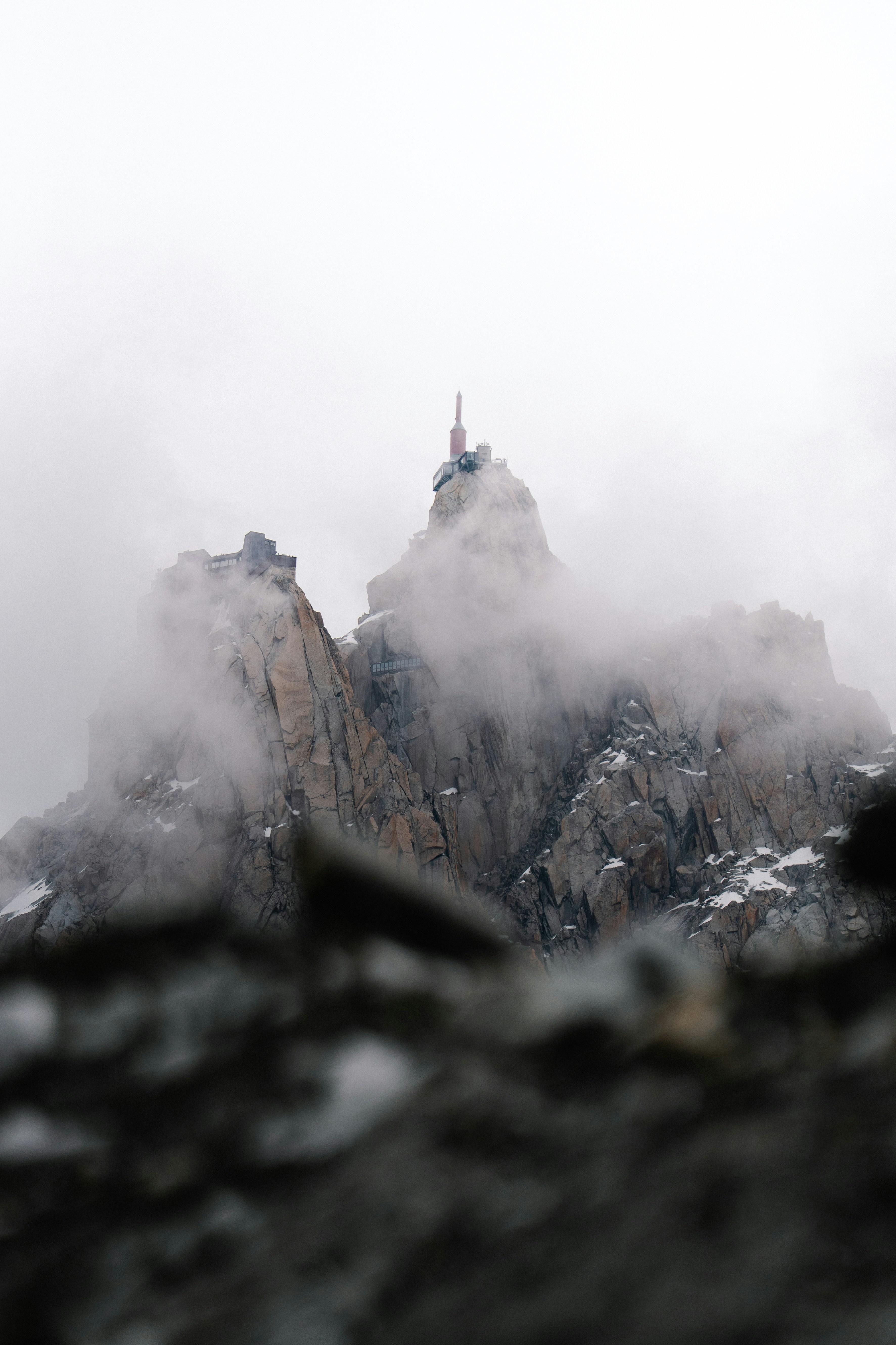 Summit Crown: A Lone Structure Piercing the Clouds