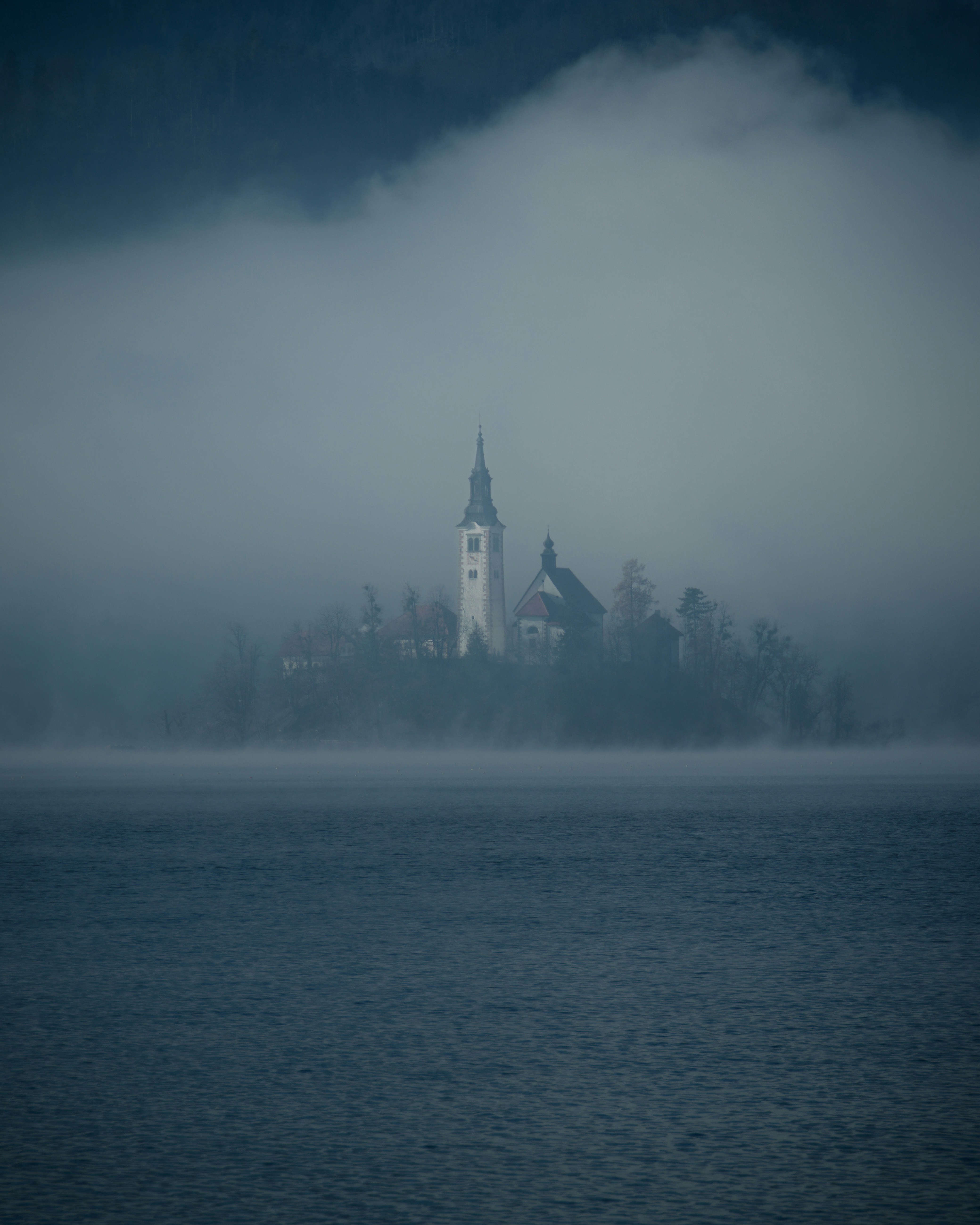 Misty Isle Rising: A Quiet Steeple Emerges Through the Fog
