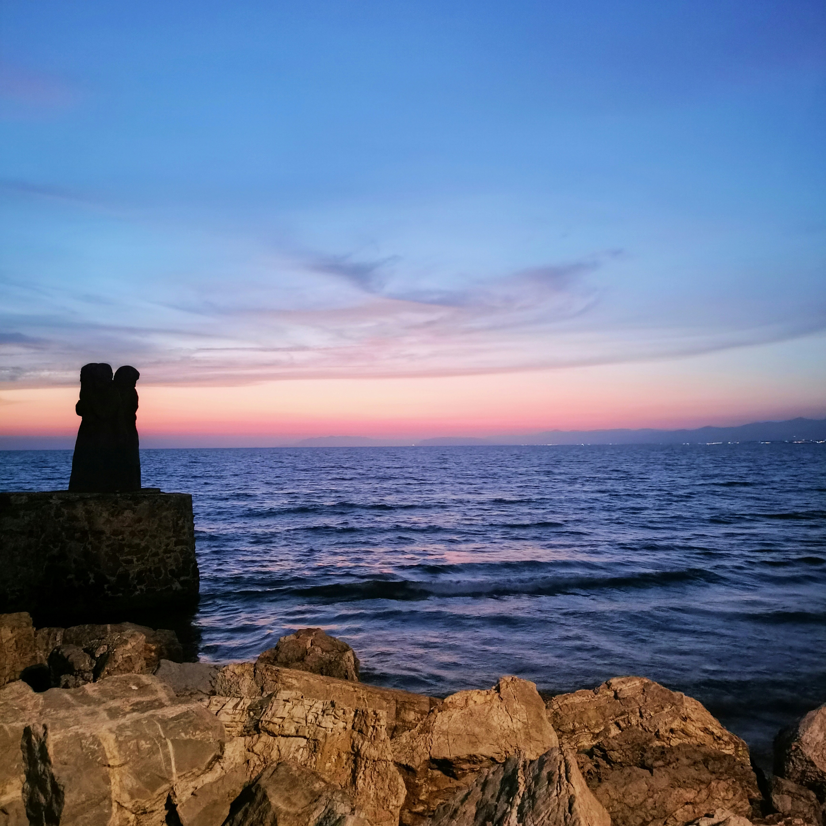 Sunset Sentinel: Stone Pillar by the Quiet Sea