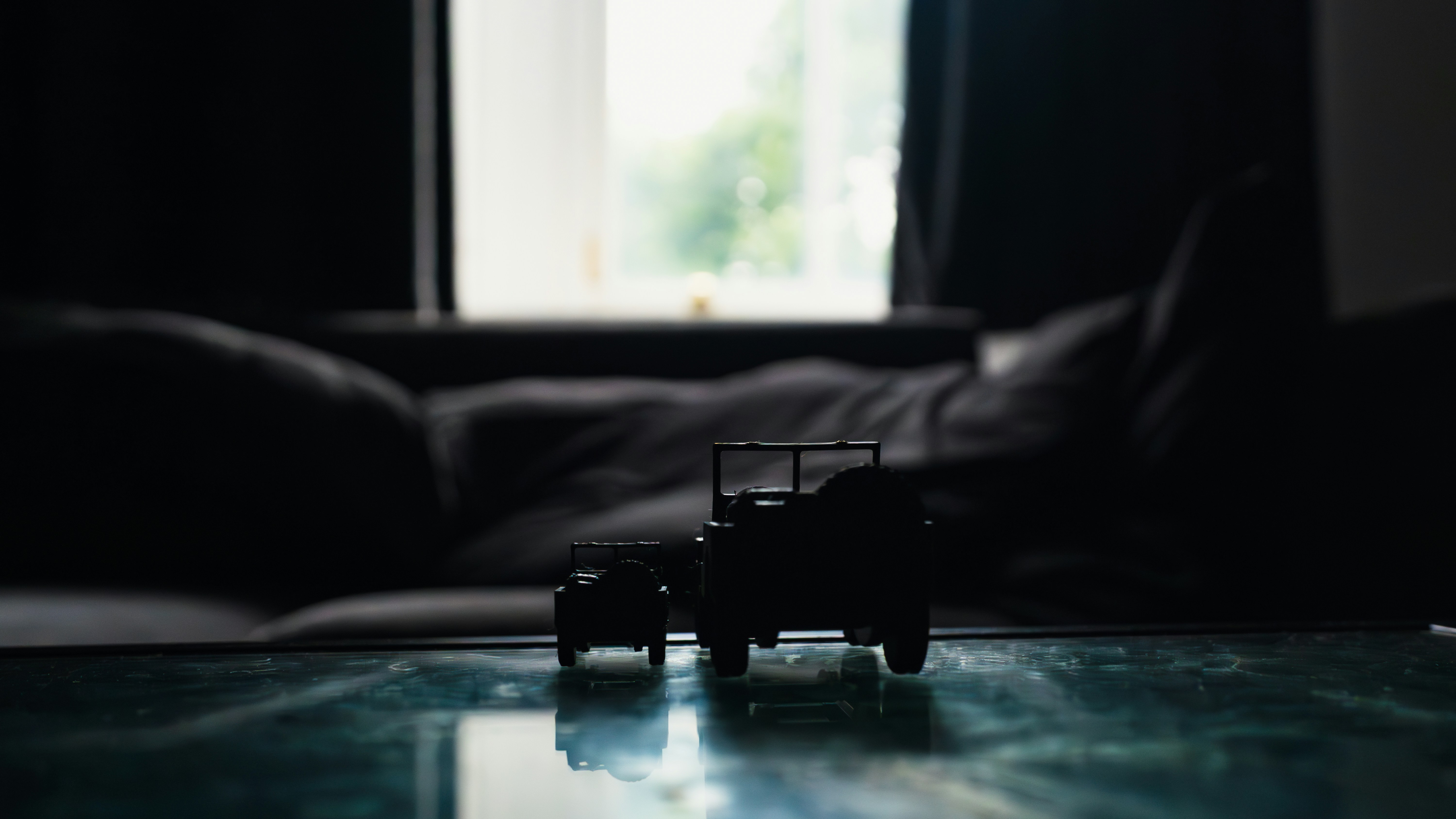 Miniature in the Spotlight: Toys Rest on a Shimmering Table