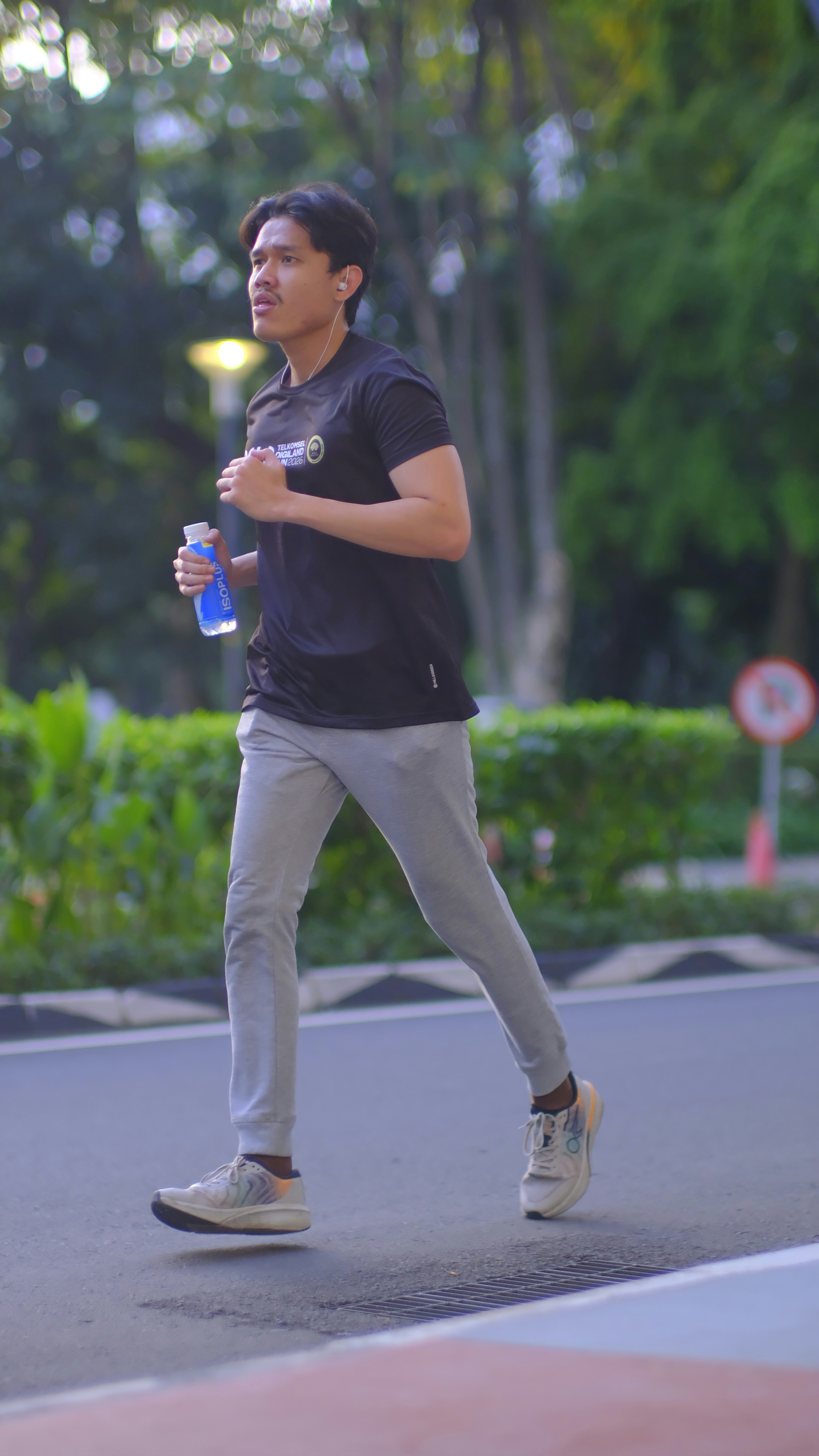 Runner in Motion: Water Bottle Reveal on a Park Path