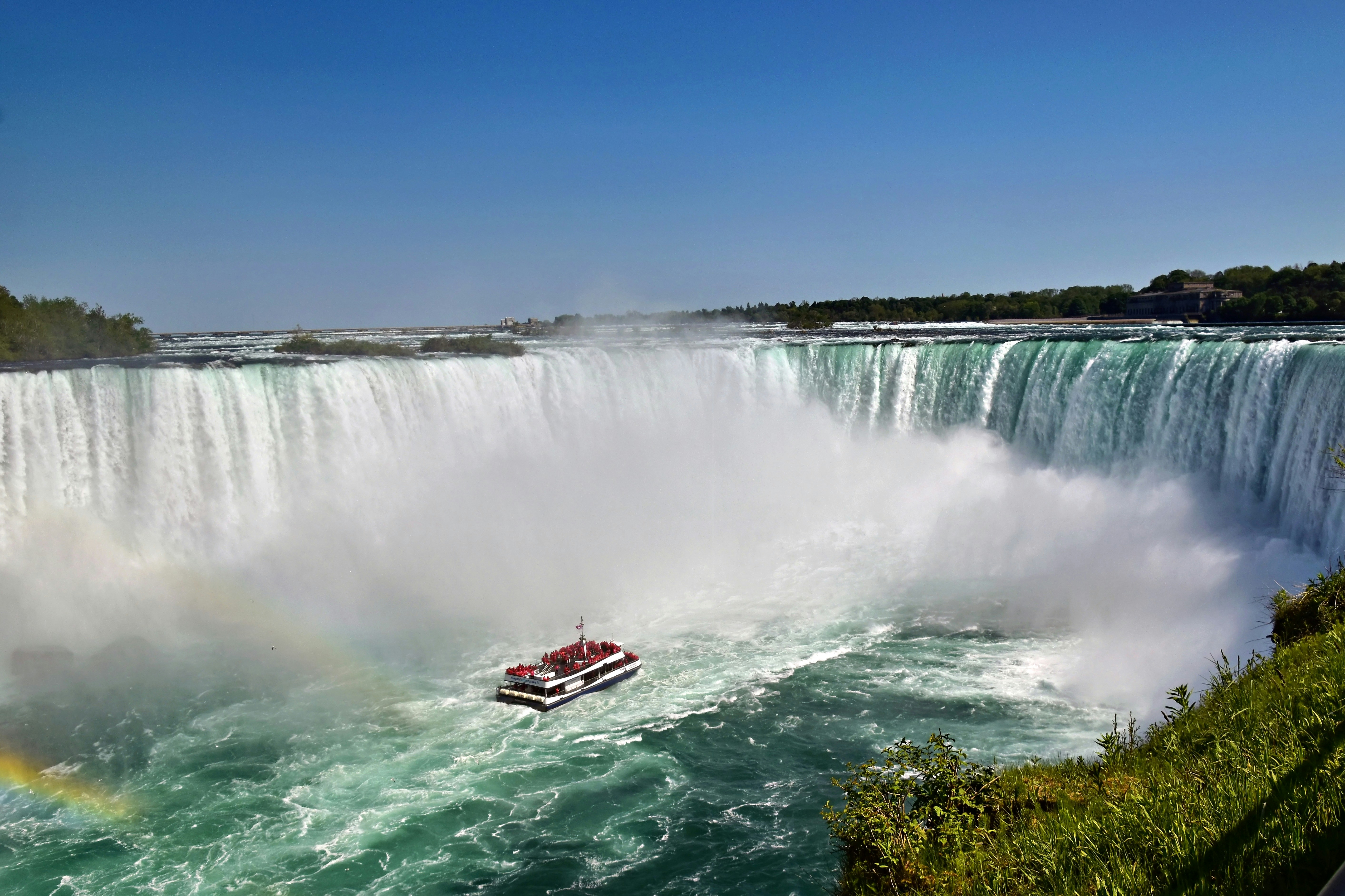 Thunderous Veil: A Tour Boat Navigates Niagara’s Emerald Curtain