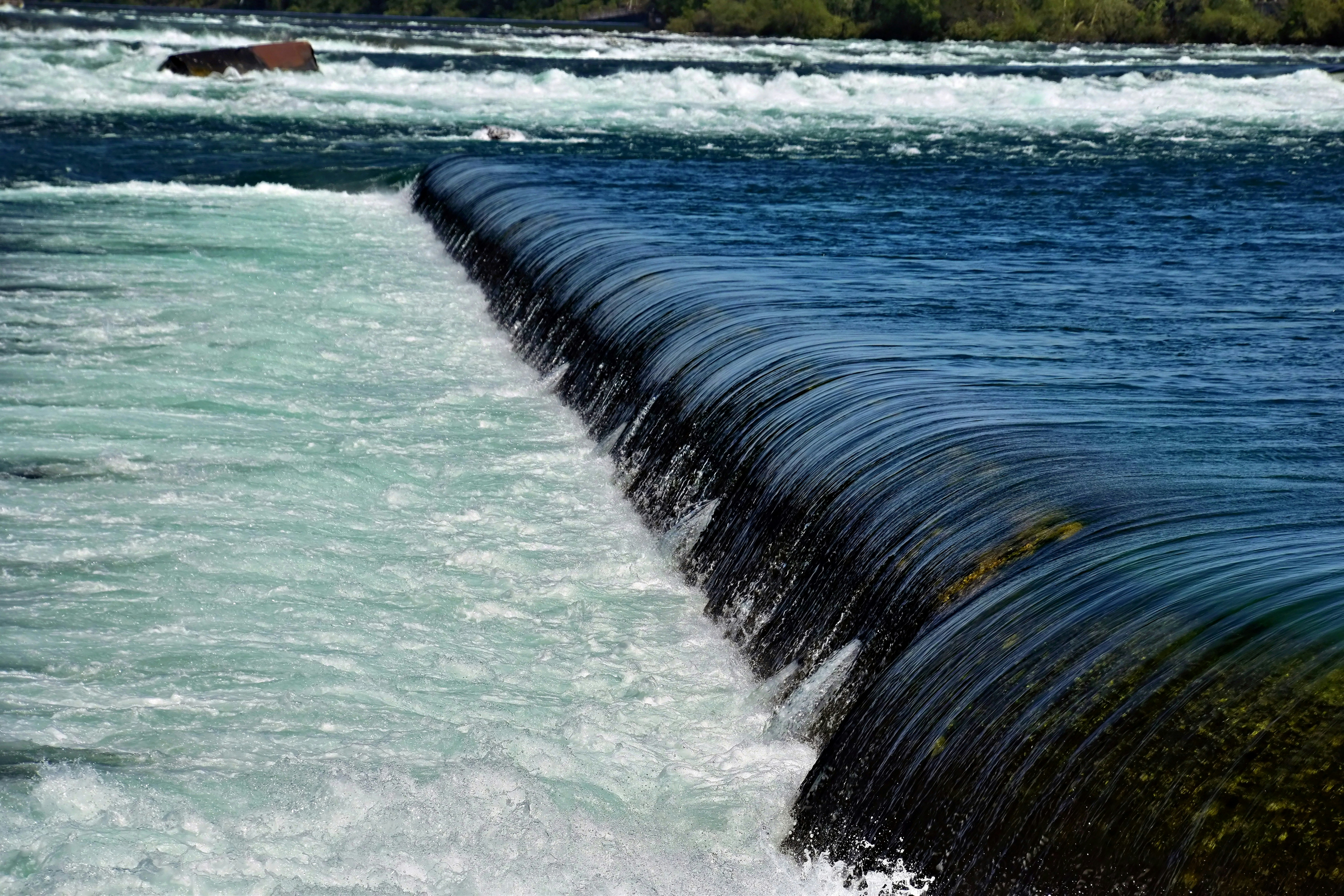 Edge of the Curtain: A Serene Waterfall Fold Over the Dam