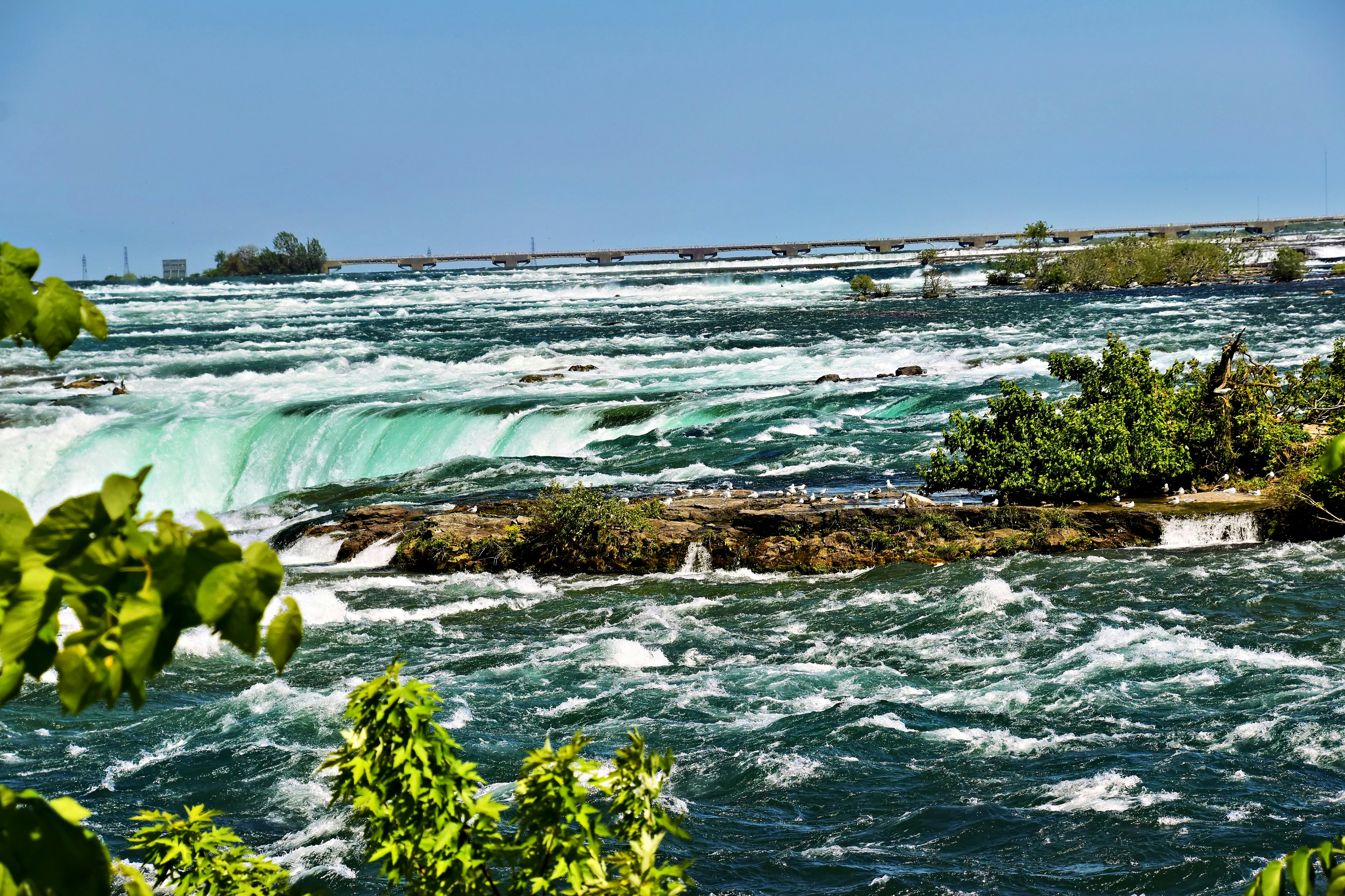 Turquoise Curtain: A Wide View of a Rosy Horizon Waterfall