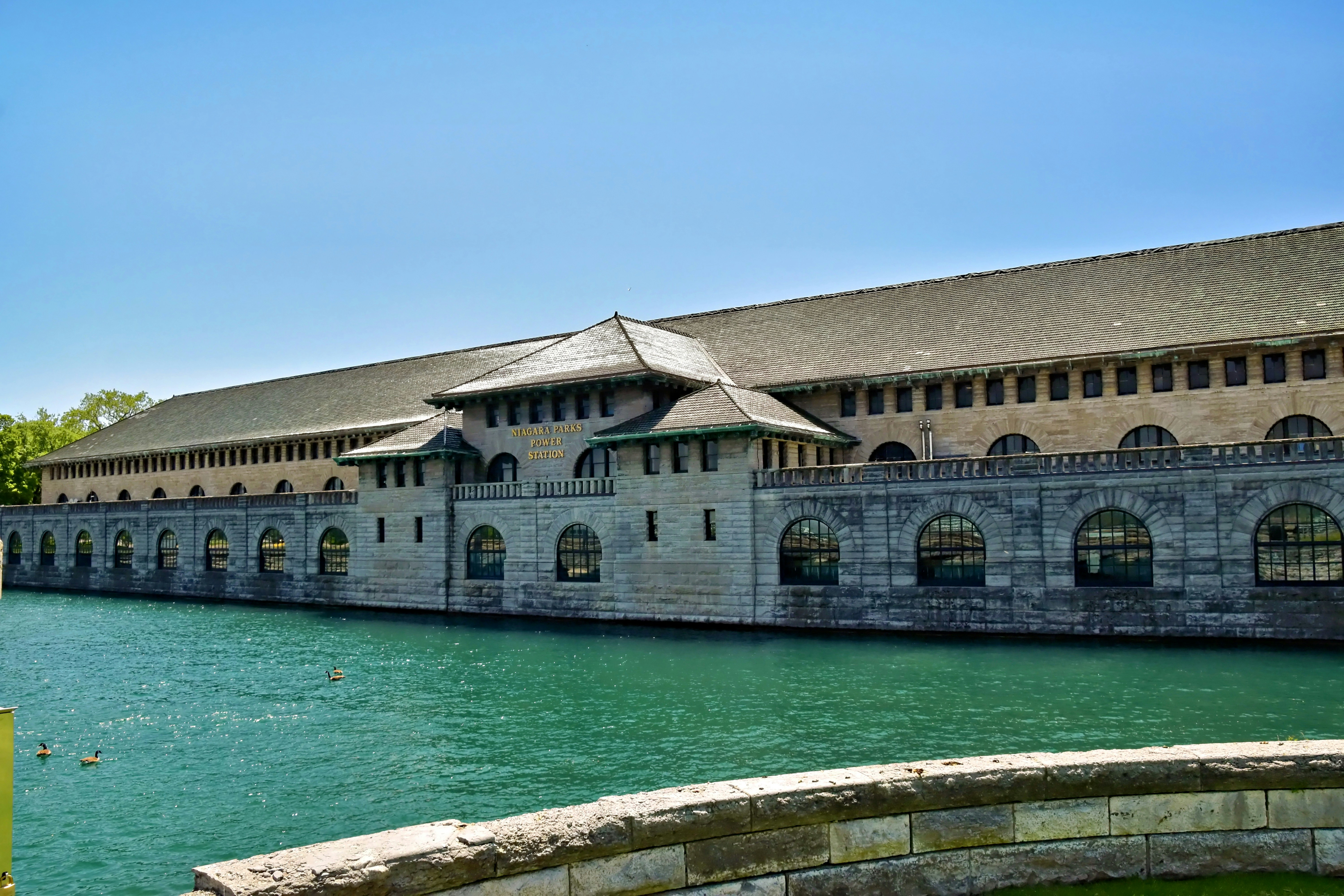 Waterfront Fortress: A Historic Stone Span Along a Turquoise Channel