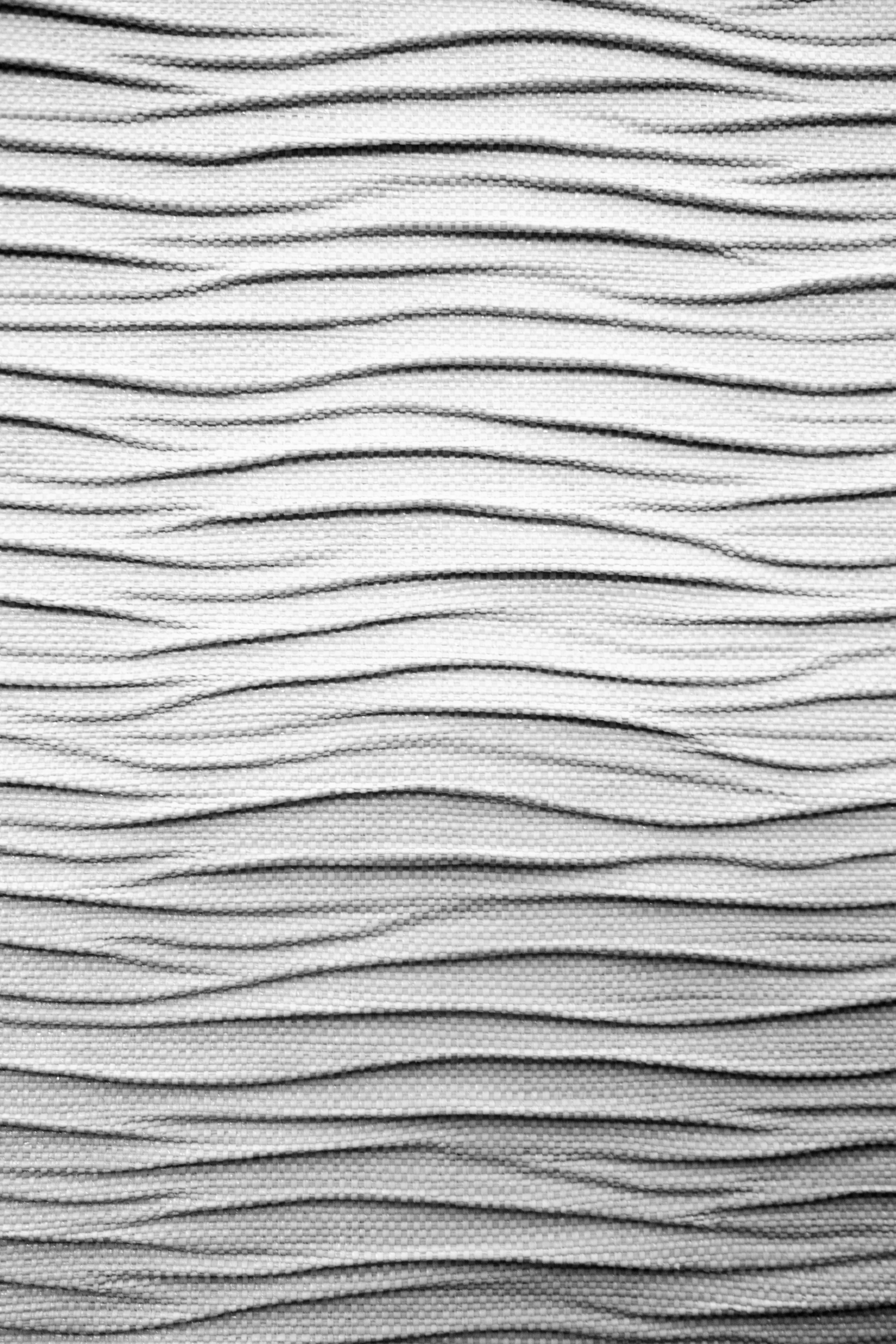 A textured surface with wavy horizontal lines in grayscale.